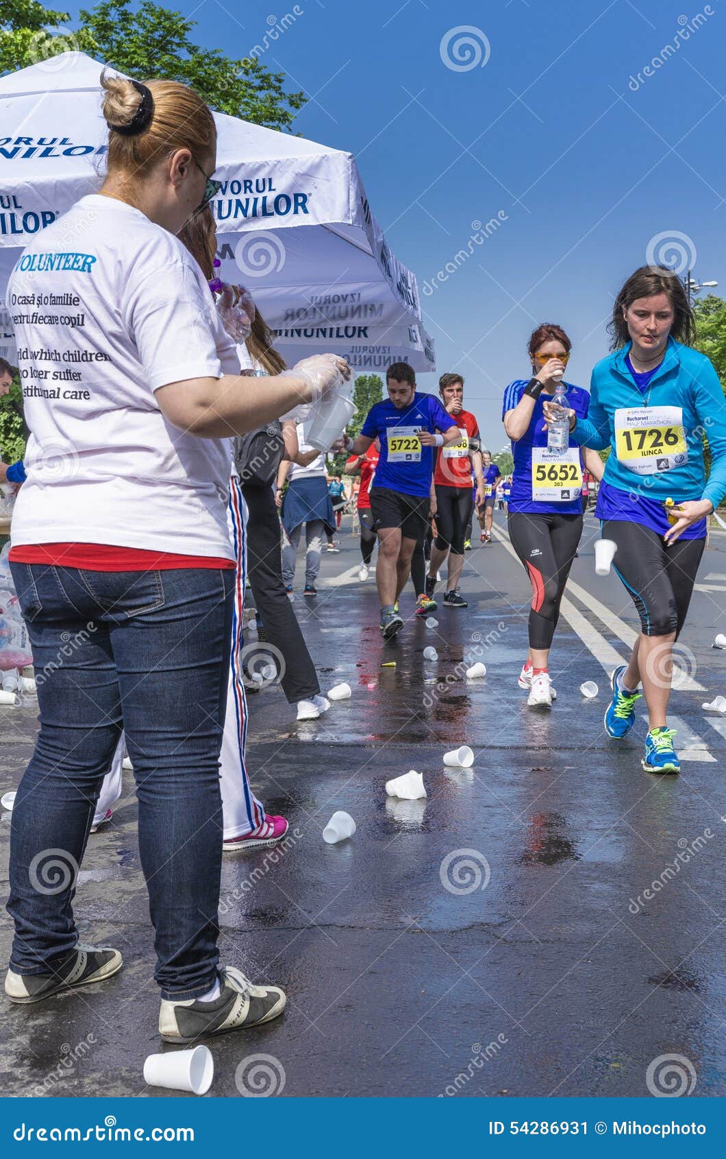 Runner Take a Water in a Marathon Race Editorial Photo - Image of ...