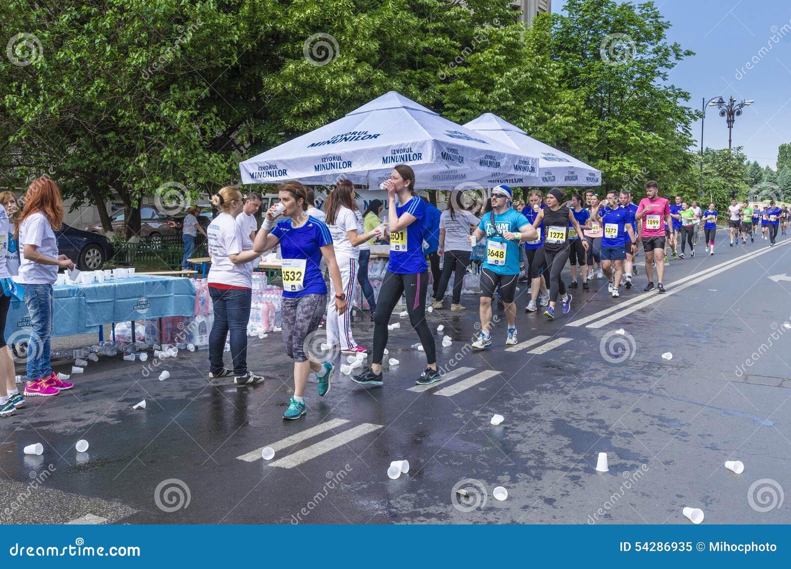 Runners Take a Water in a Marathon Race Editorial Image - Image of ...