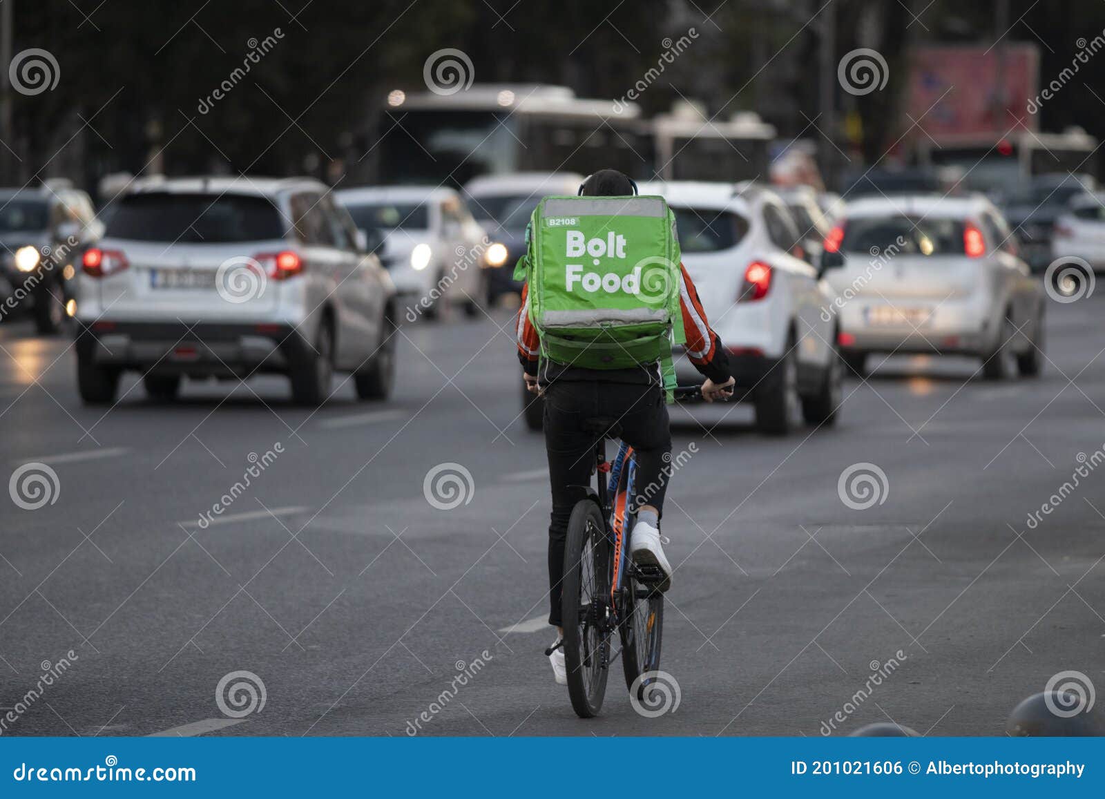 Bolt Food Courier On A Bicycle Carrying The Green Delivery Bag. Young ...