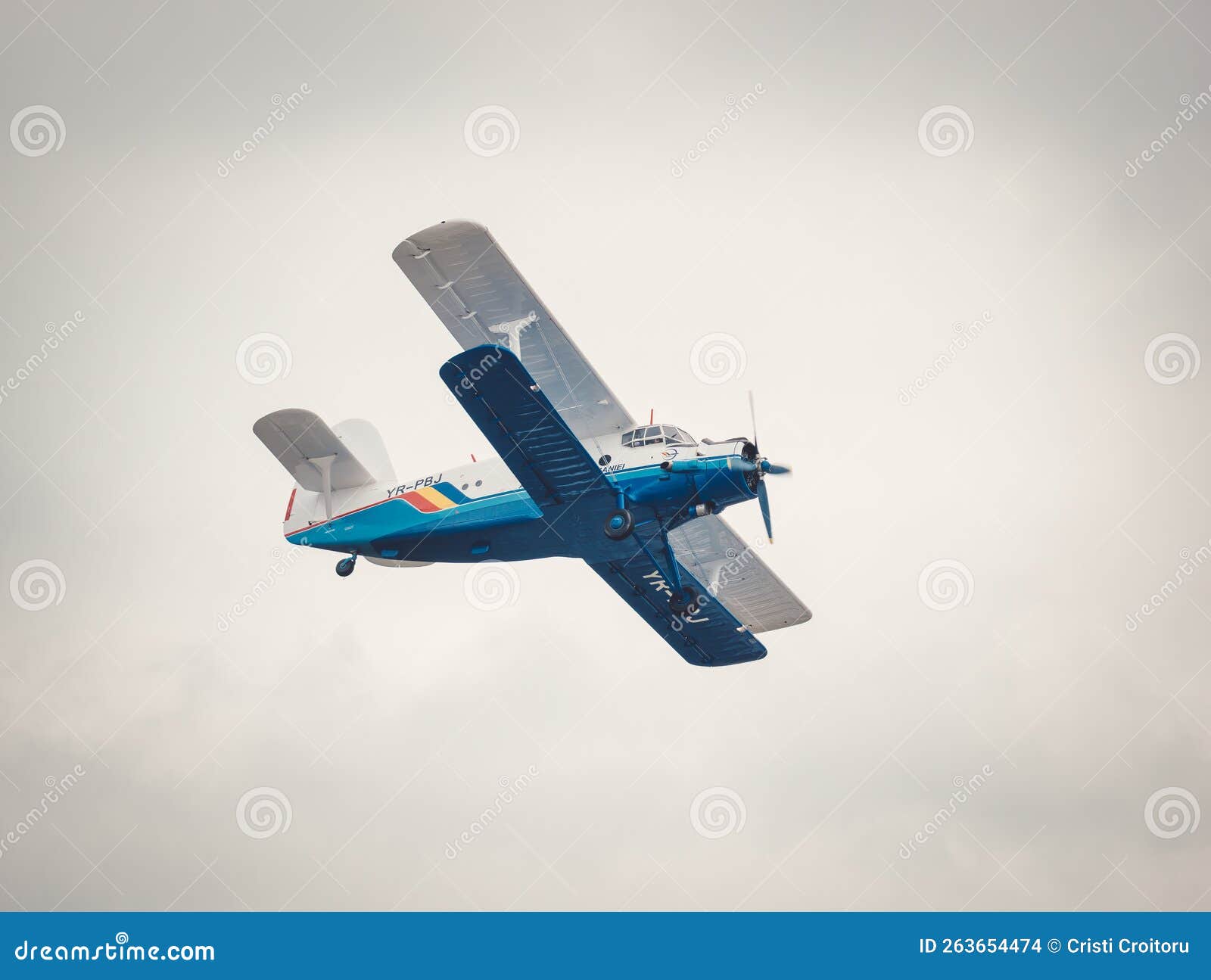 A Soviet Antonov an-2 Single-engine Biplane Flying Against Blue Sky ...