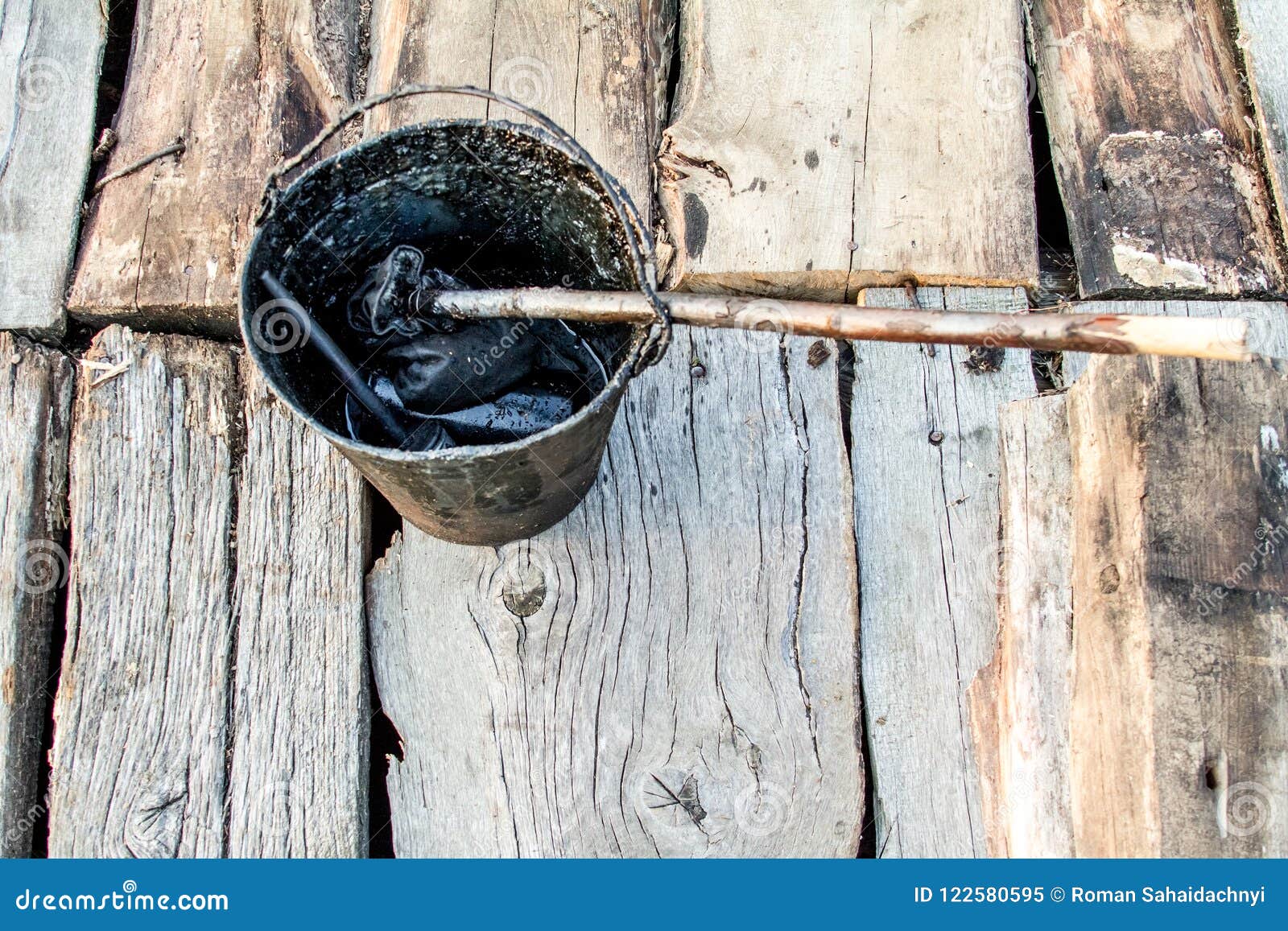 A Bucket of Black Tar Boils on the Fire for Use in Repair and ...