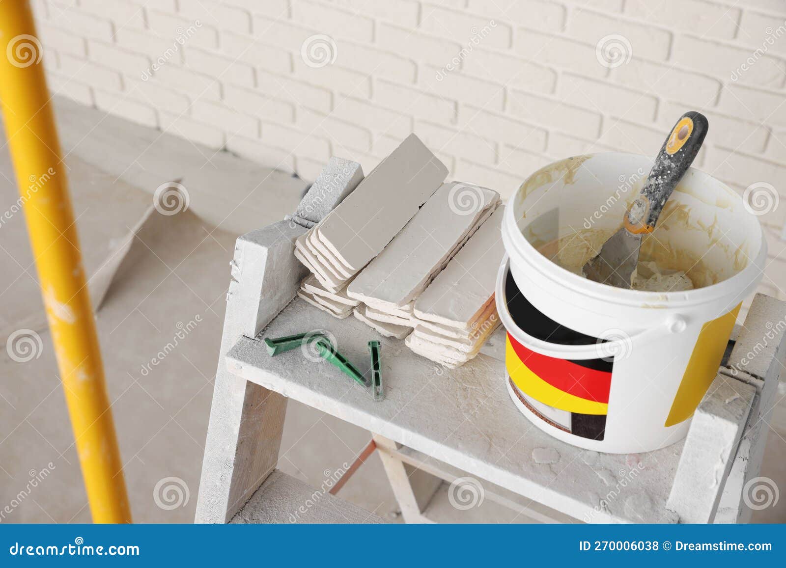 Bucket with Cement, Tile Spacers and Many White Decorative Bricks in ...
