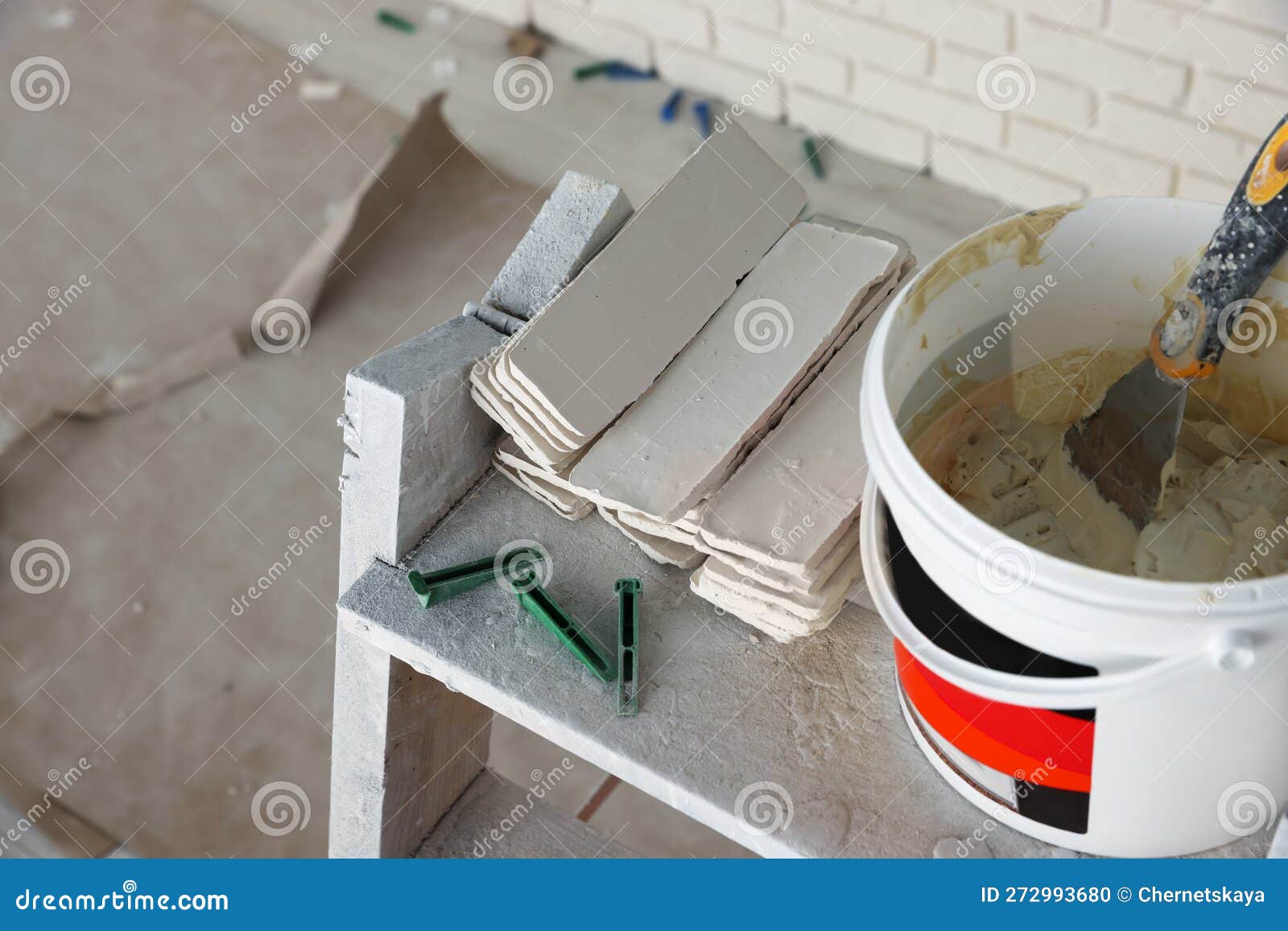 Bucket with Cement, Tile Spacers and Many White Decorative Bricks in ...