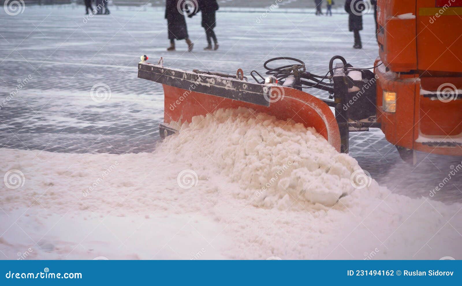 A Bucket Close-up Cleans the Sidewalk from Snow. the Tractor Cleans the ... A Bucket Close-up Cleans the Sidewalk from Snow. the Tractor Cleans the ...