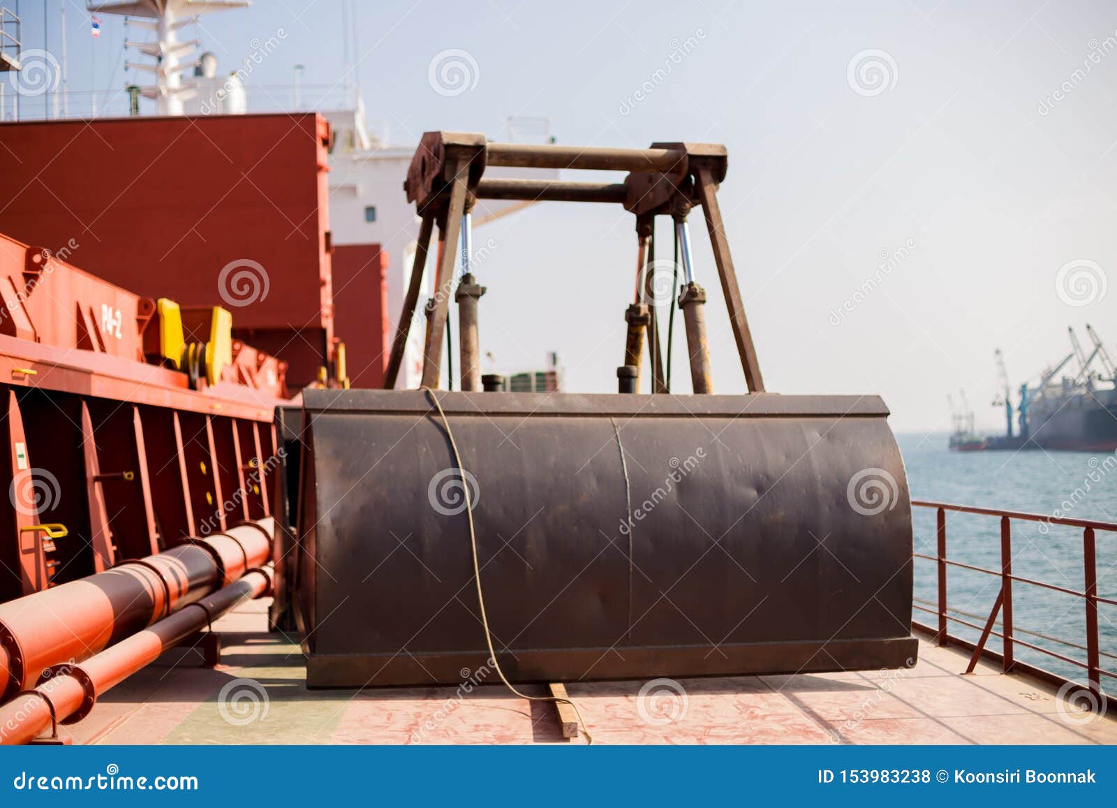 Bucket and Crane for Loading on Cargo Ship. Shipment from a Merchant ...
