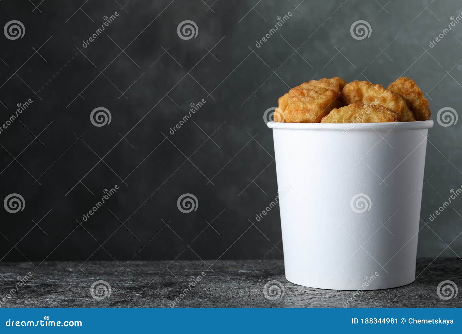 Bucket with Delicious Chicken Nuggets on Background. Space for Text ...