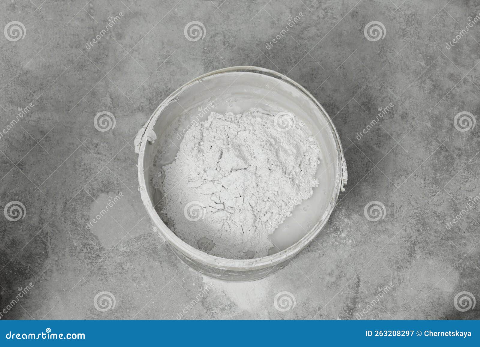Bucket with Powdered Plaster and Liquid on Concrete Floor, Top View ...