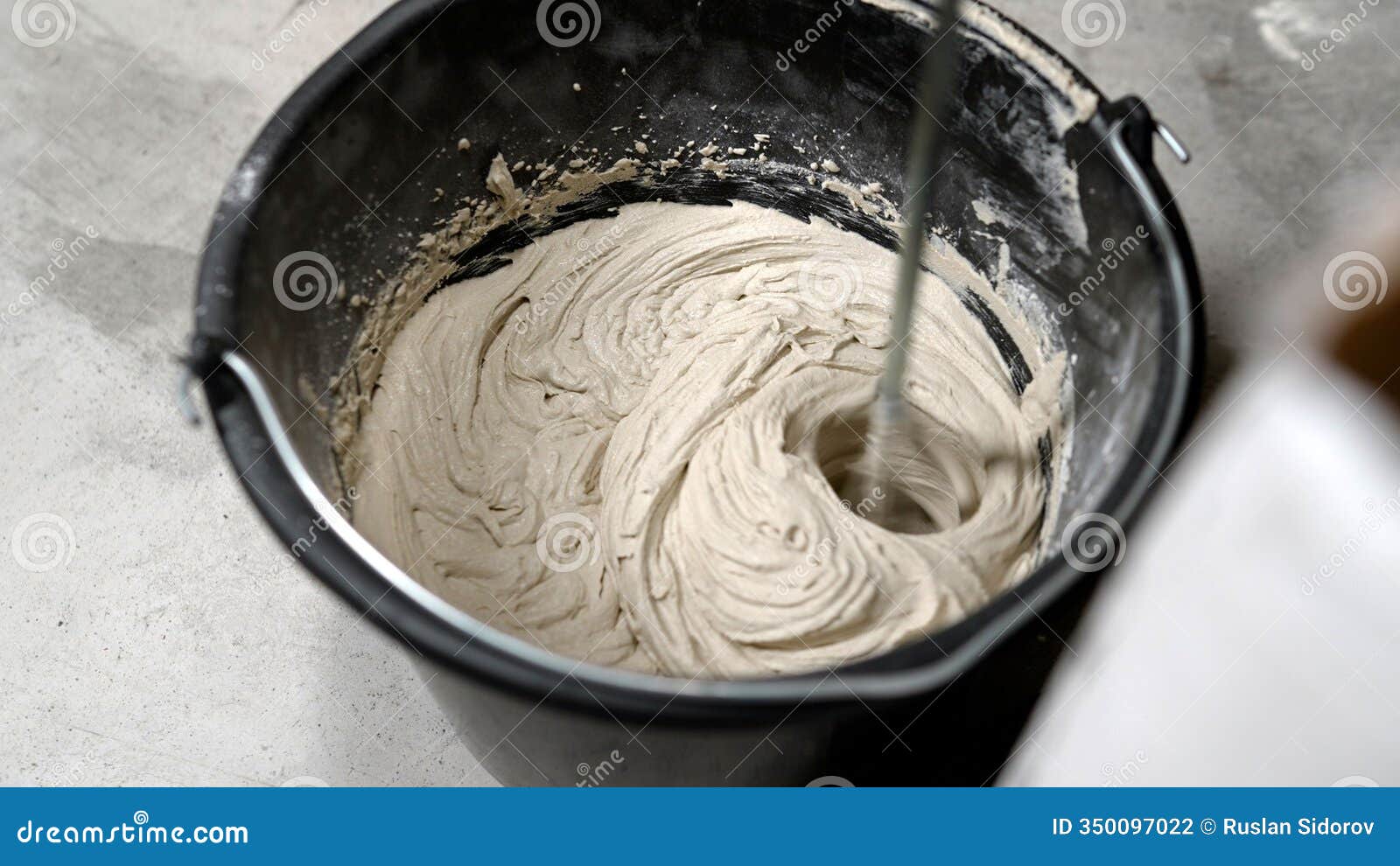 A Bucket with a Solution is Mixed with a Construction Mixer. we Mix the ...