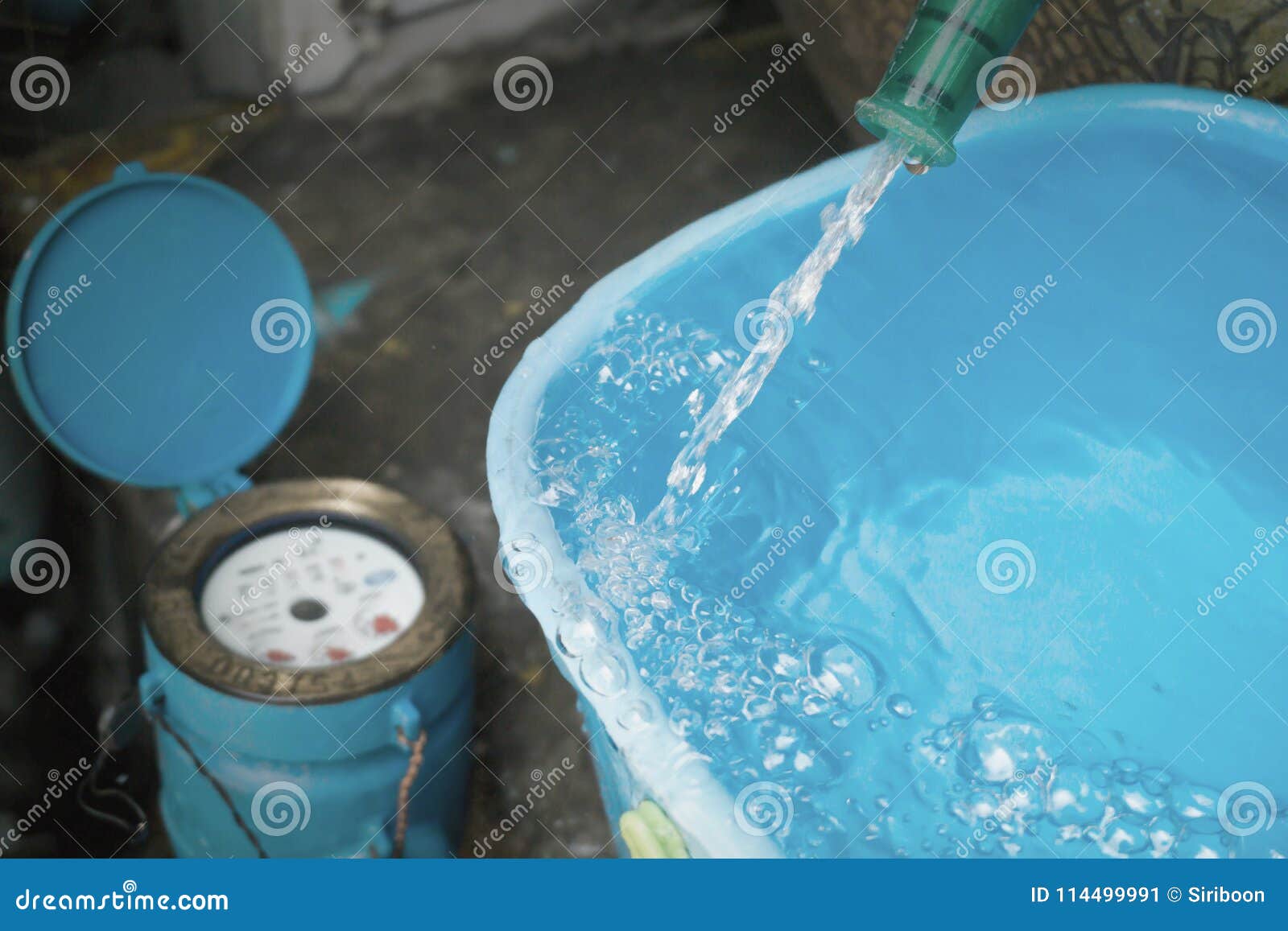 Bucket with Water Overflowing. and Water Meter Behind Scene Stock Image ...
