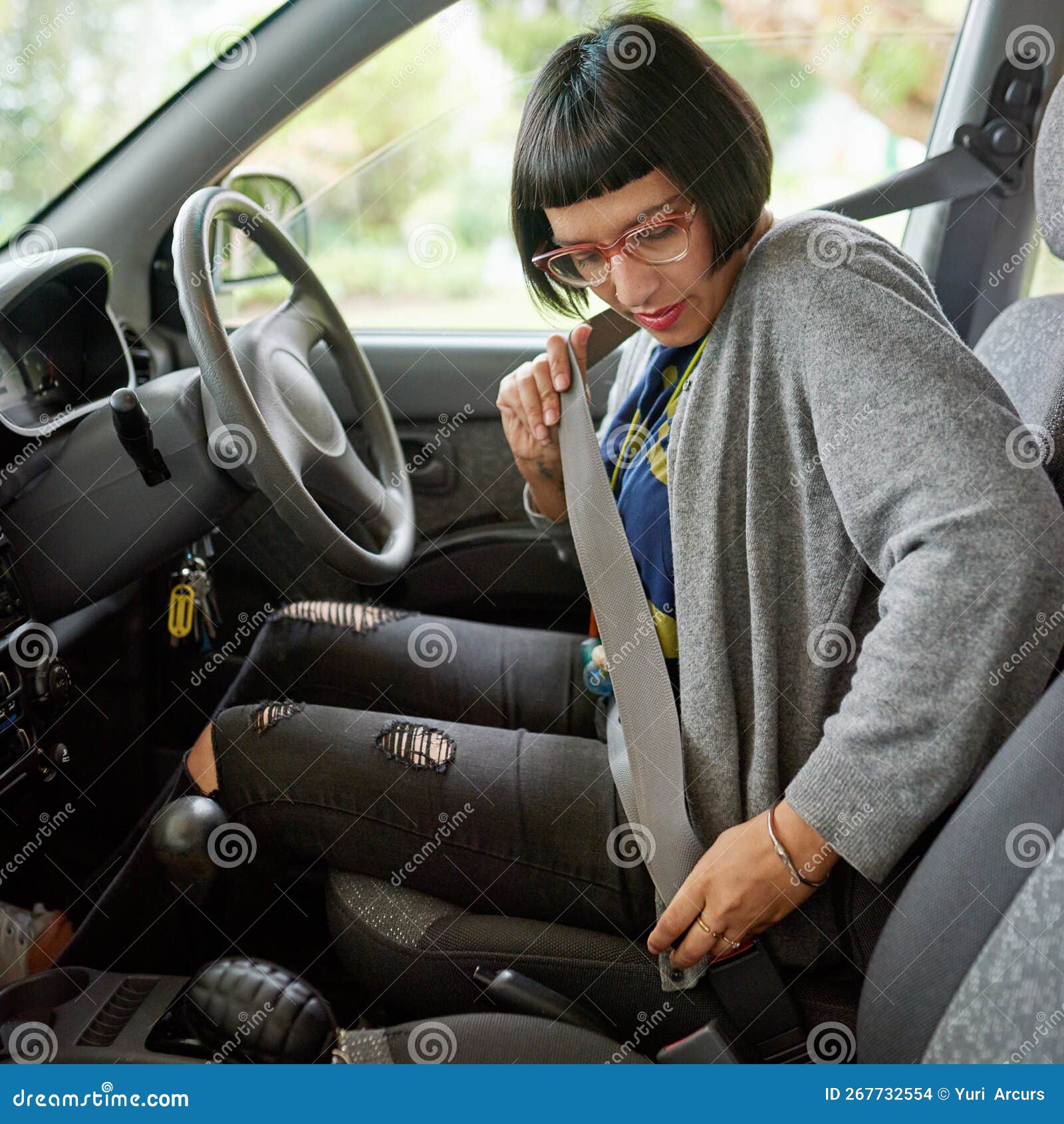 Always Buckle Up A Young Woman Buckling Up Her Seat Belt Before Going