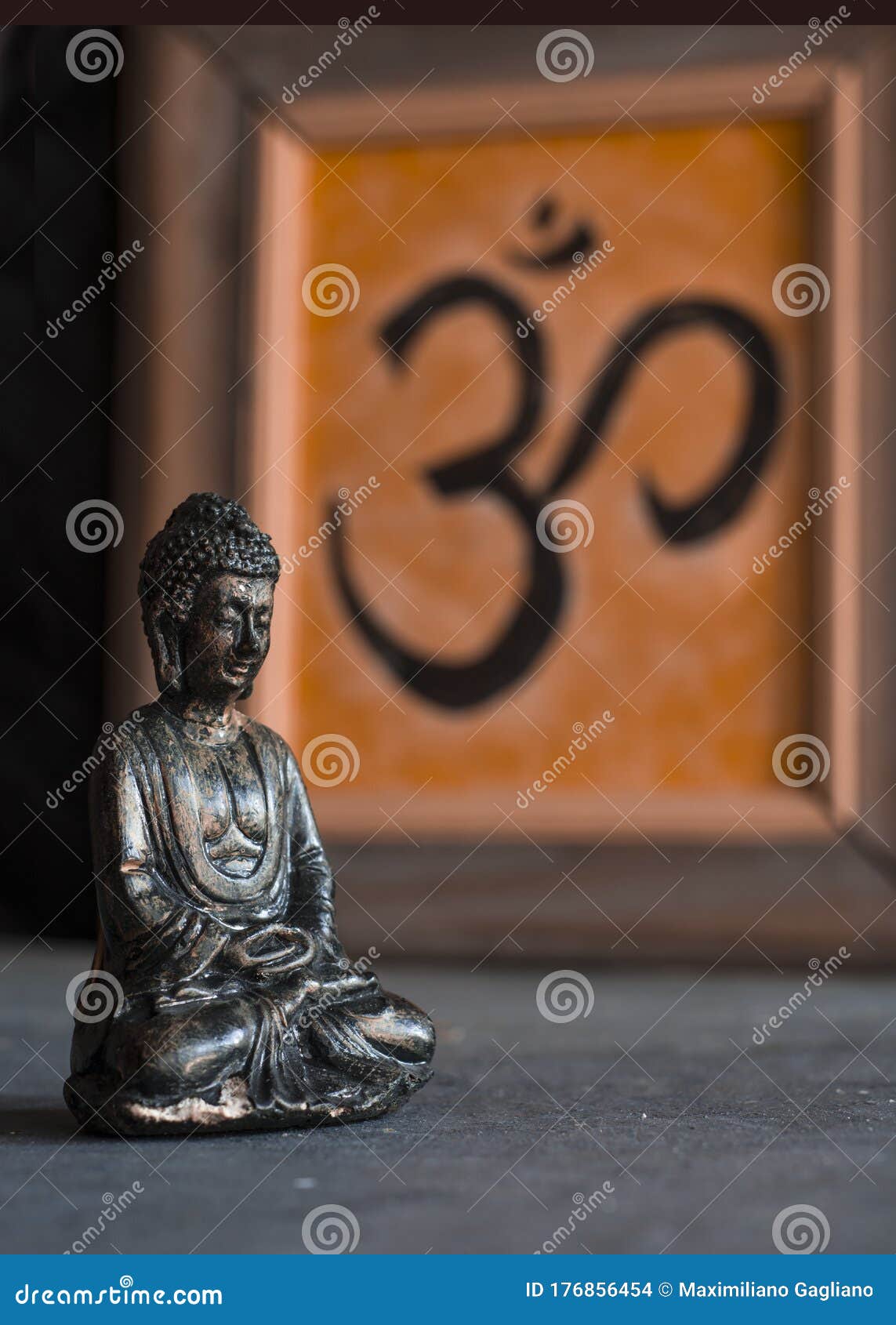 A Buddha on a Table with an Om Mantra Symbol Stock Photo - Image of ...