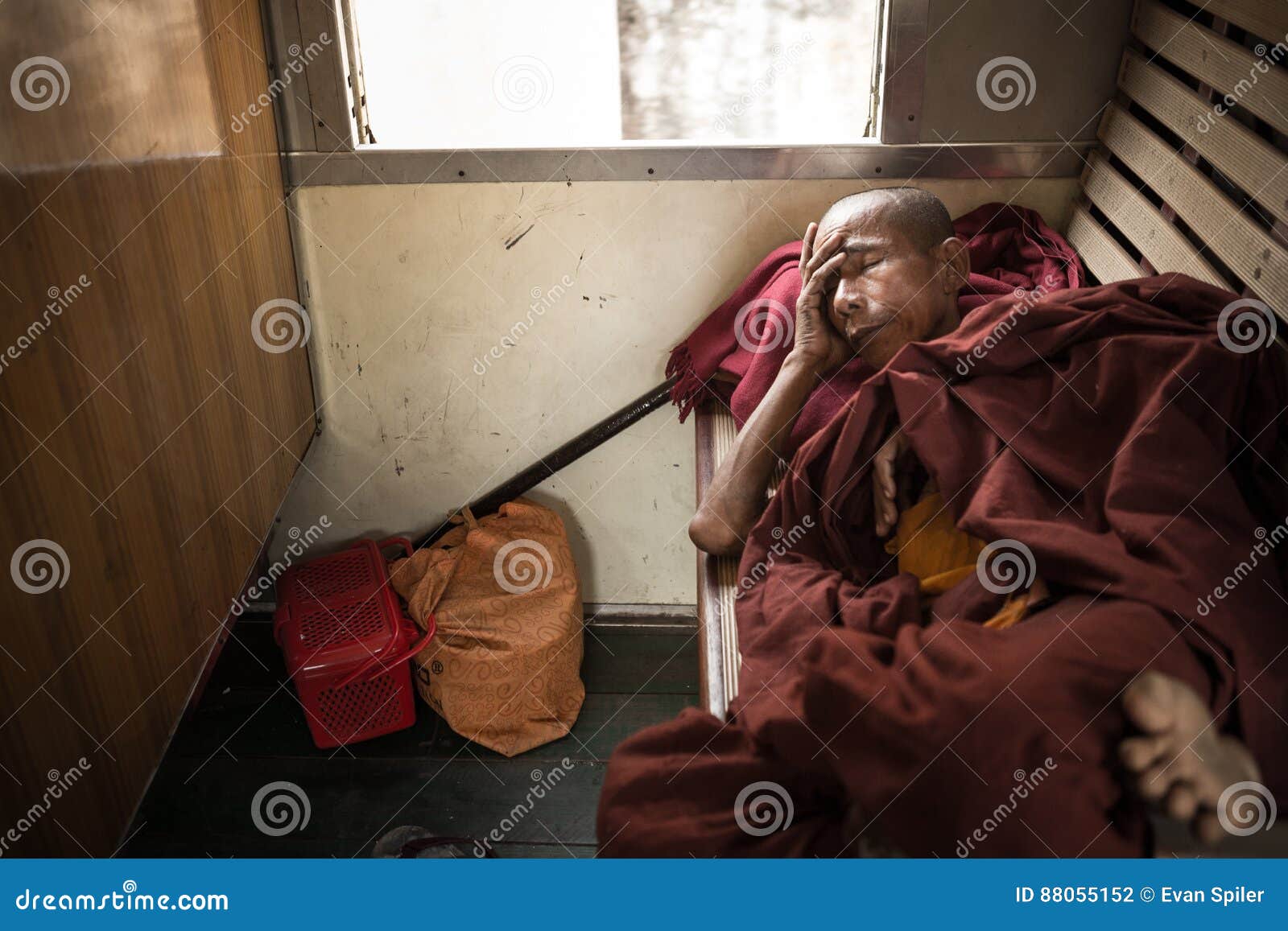 A Monk Is Sleep On Wooden Chairs Are Waiting For Trains In The Area ...