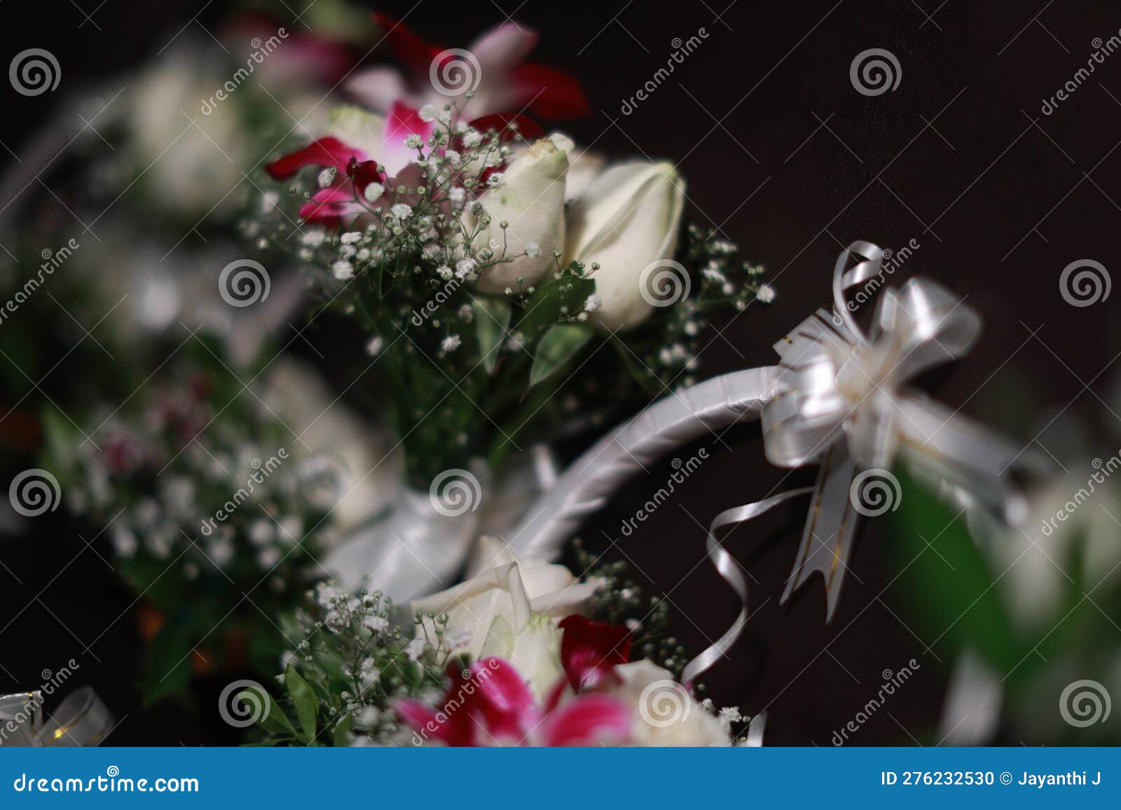 Budding White Roses Highlighted on a Bouquet of Flowers Stock Photo ...