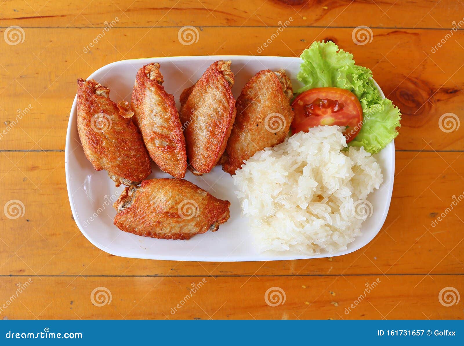 Buffalo Chicken Wings with Sticky Rice on White Plate Stock Image ...