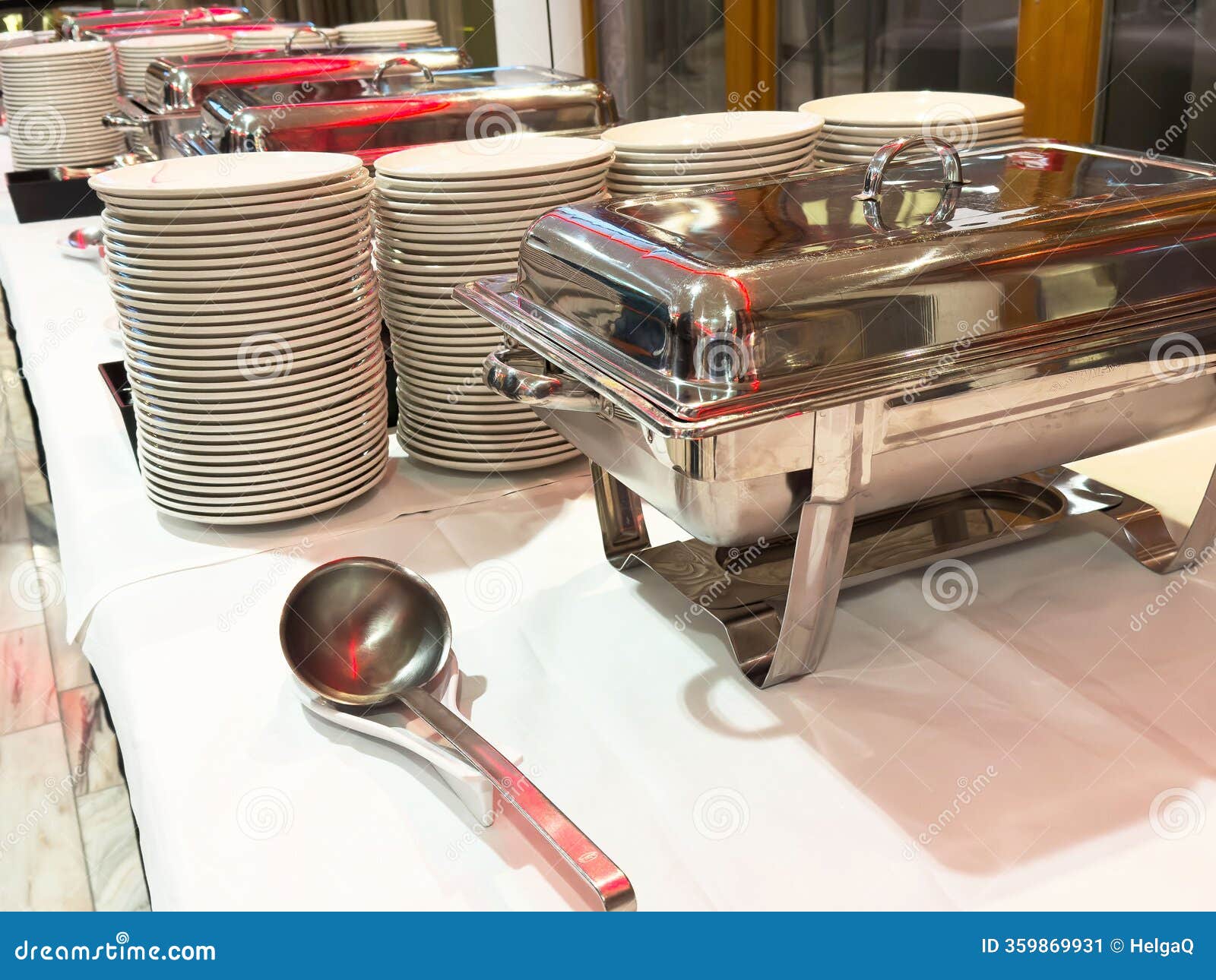 Buffet Setup with Chafing Dishes and Stacks of Plates Ready for ...