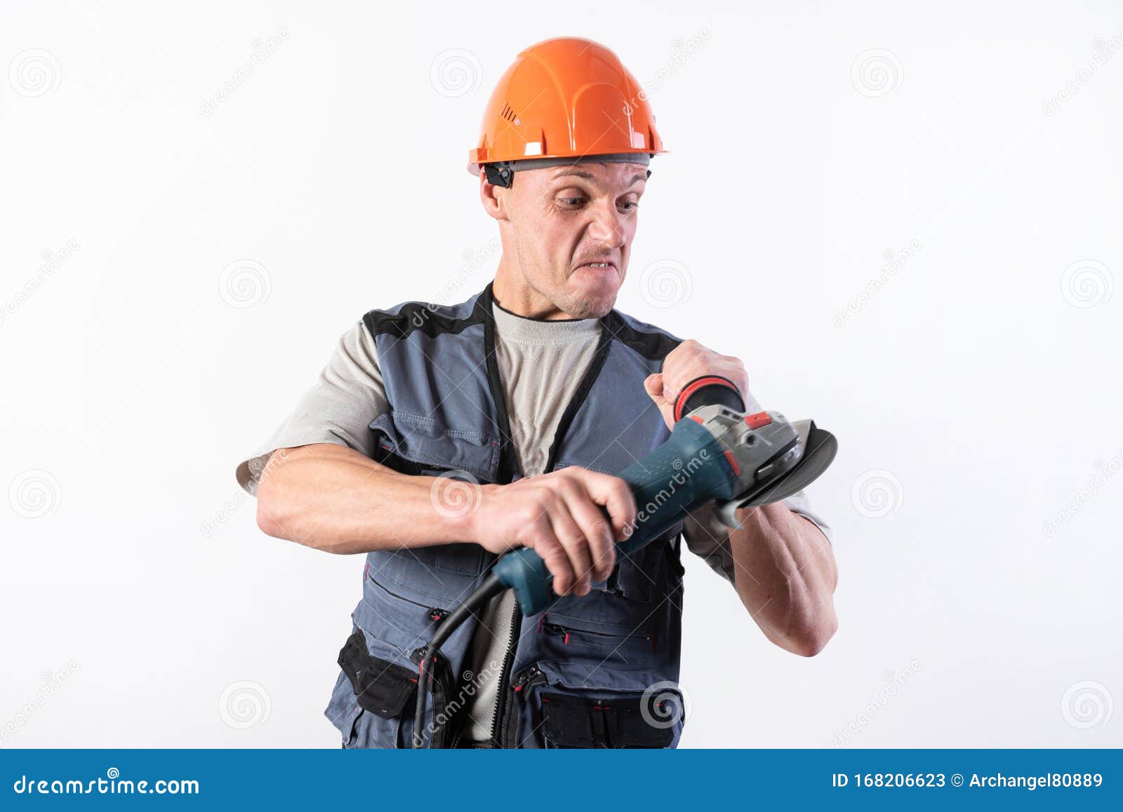 Builder with Angle Grinder, in a Helmet, with a Funny Expression on His ...