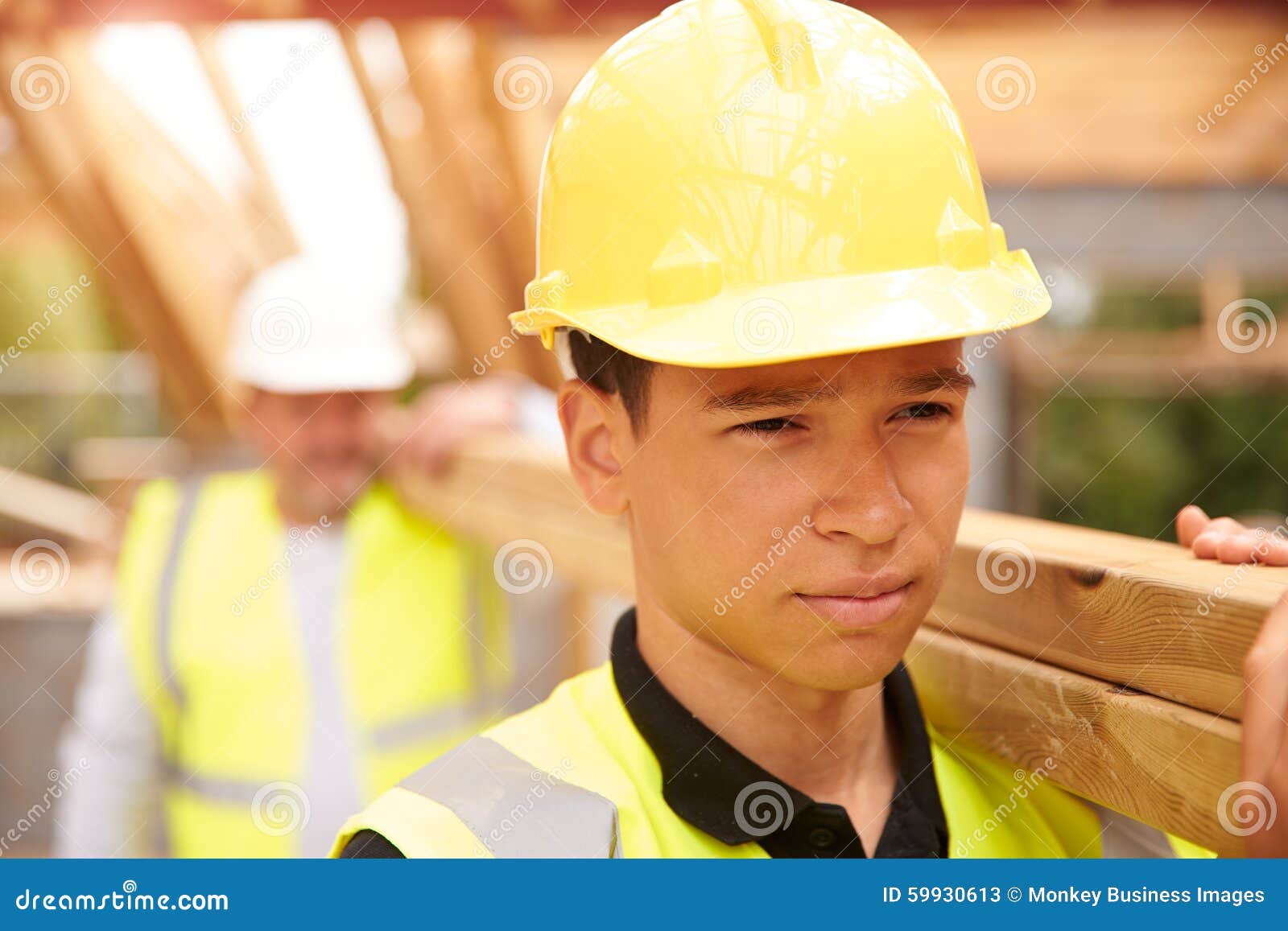 Builder and Apprentice Carrying Wood on Construction Site Stock Image ...