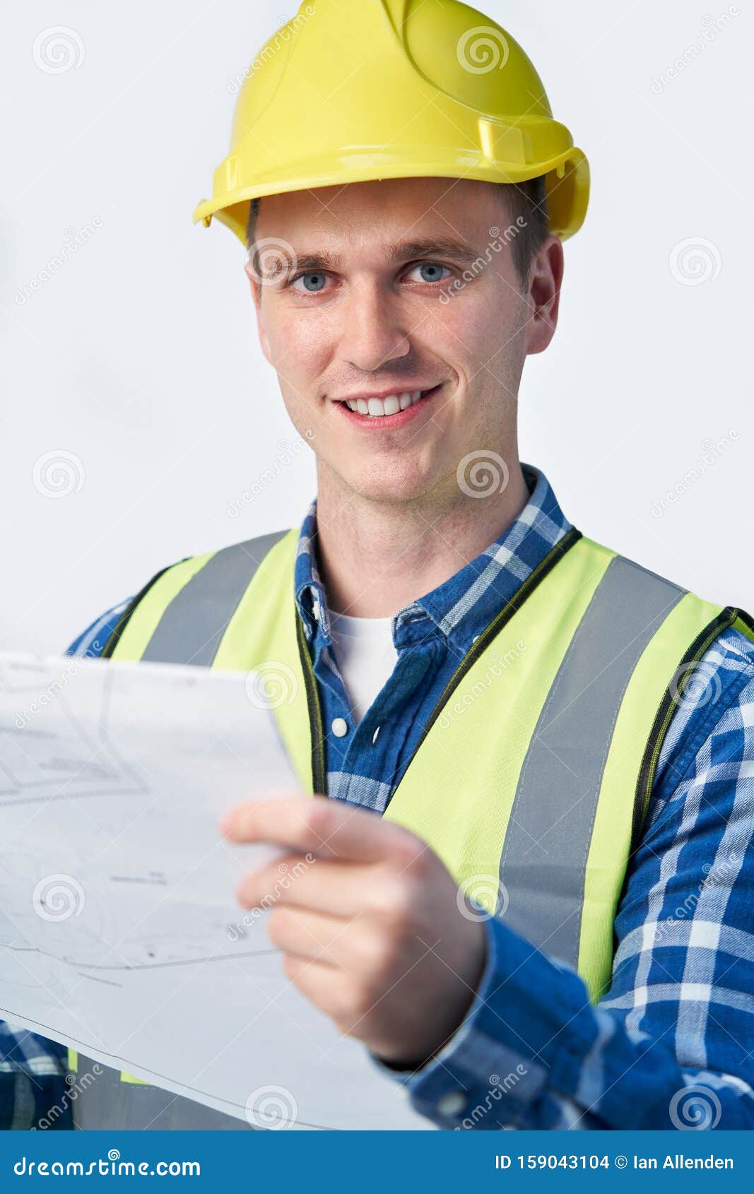Studio Portrait of Builder Architect Looking at Plans Against White ...