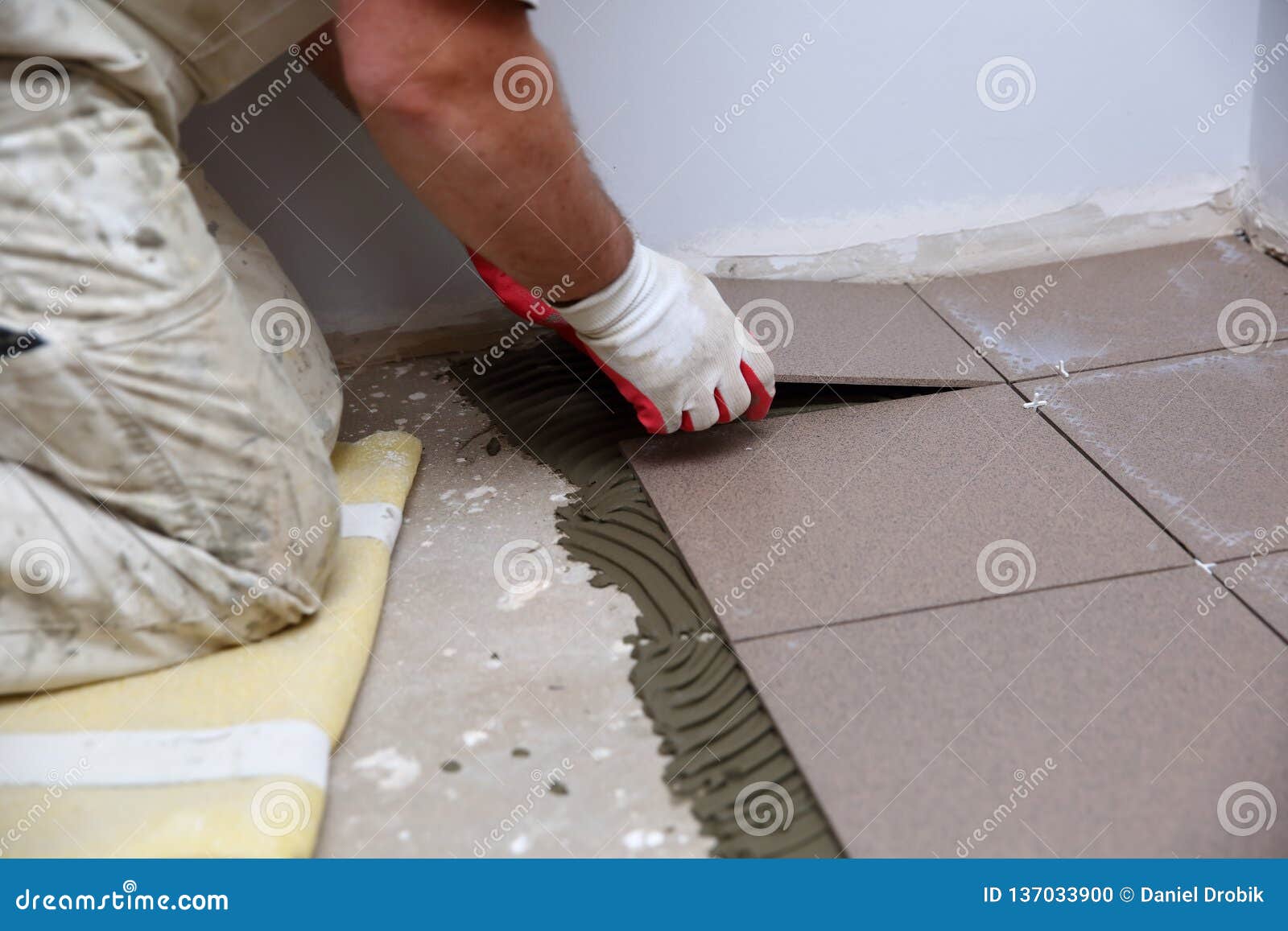 The Builder Arranges Ceramic Tiles on the Stairs Inside the Building ...