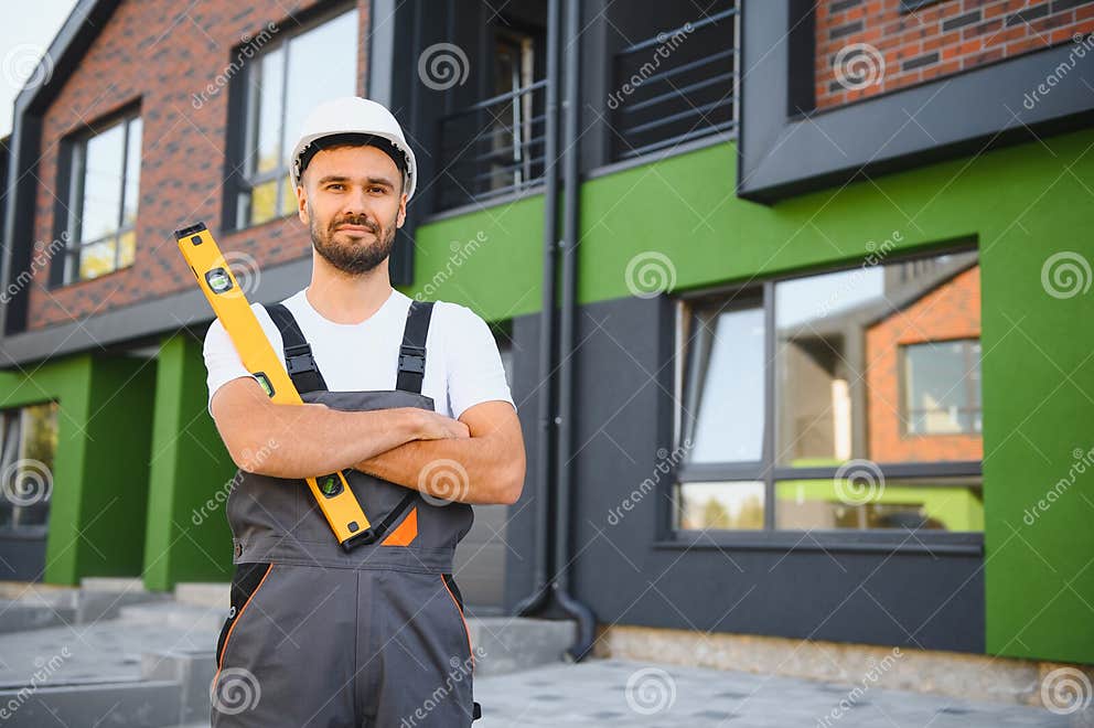 Builder on the Background of New Cottages. the Concept of the ...