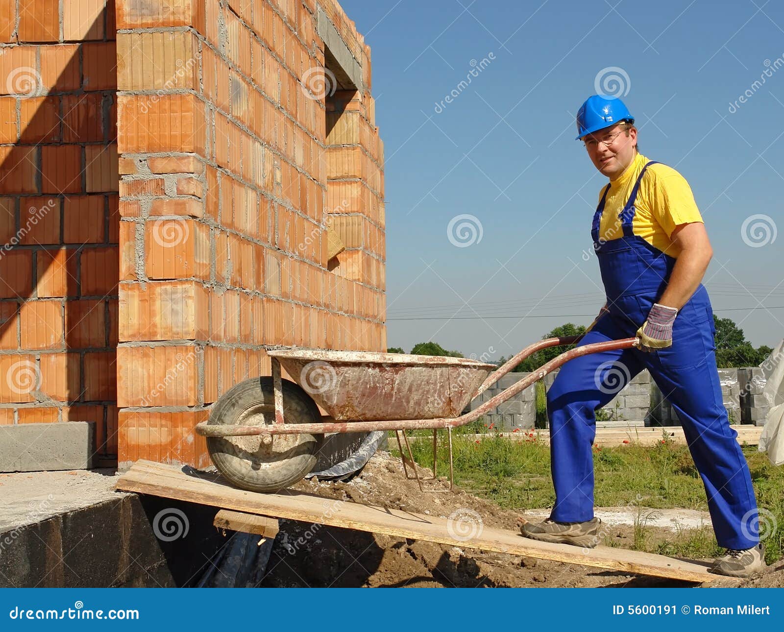Builder with barrow stock image. Image of coveralls, personnel - 5600191