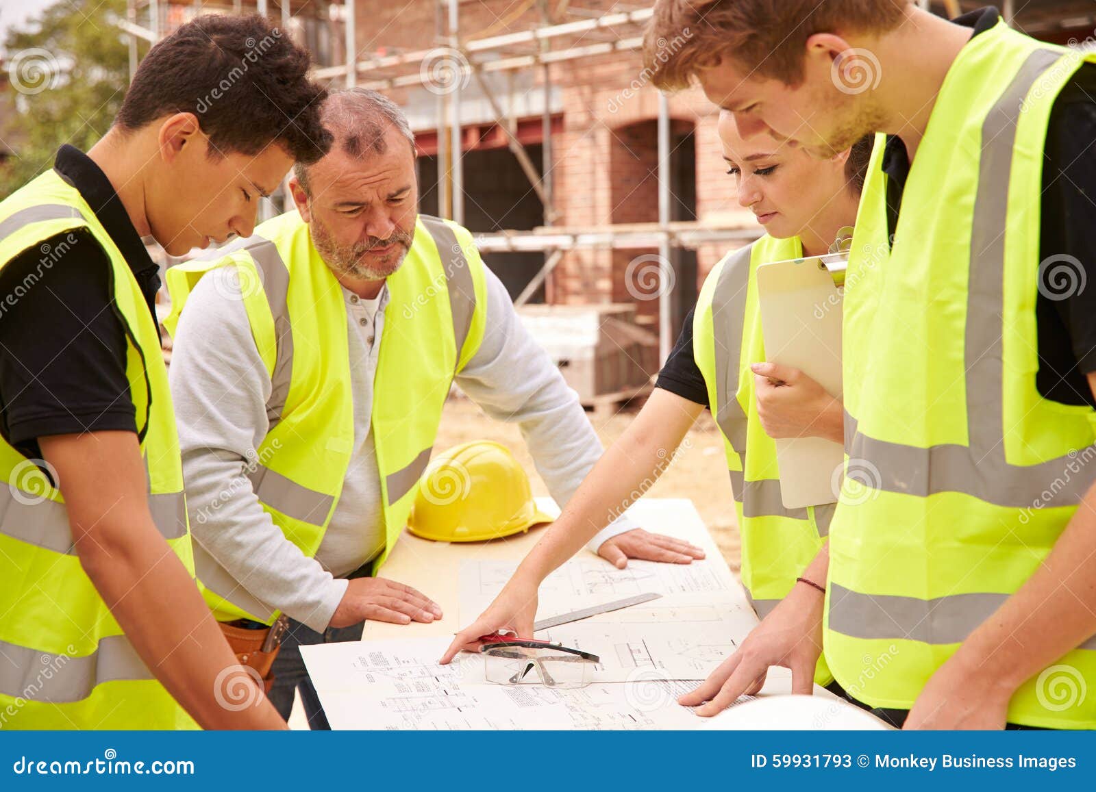 Builder on Building Site Discussing Work with Apprentice Stock Image ...