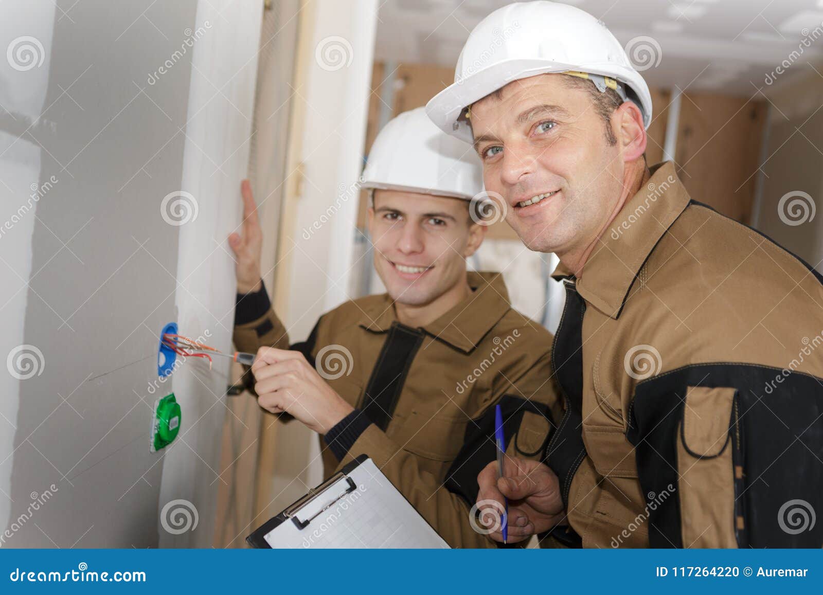 Builder on Building Site Discussing Work with Apprentice Stock Photo ...