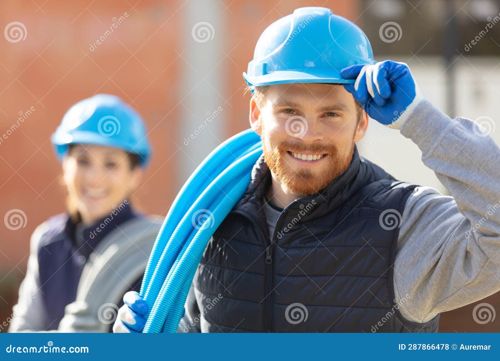 Builder Carrying Reel Blue Pipe on Shoulder Stock Photo - Image of blue ...