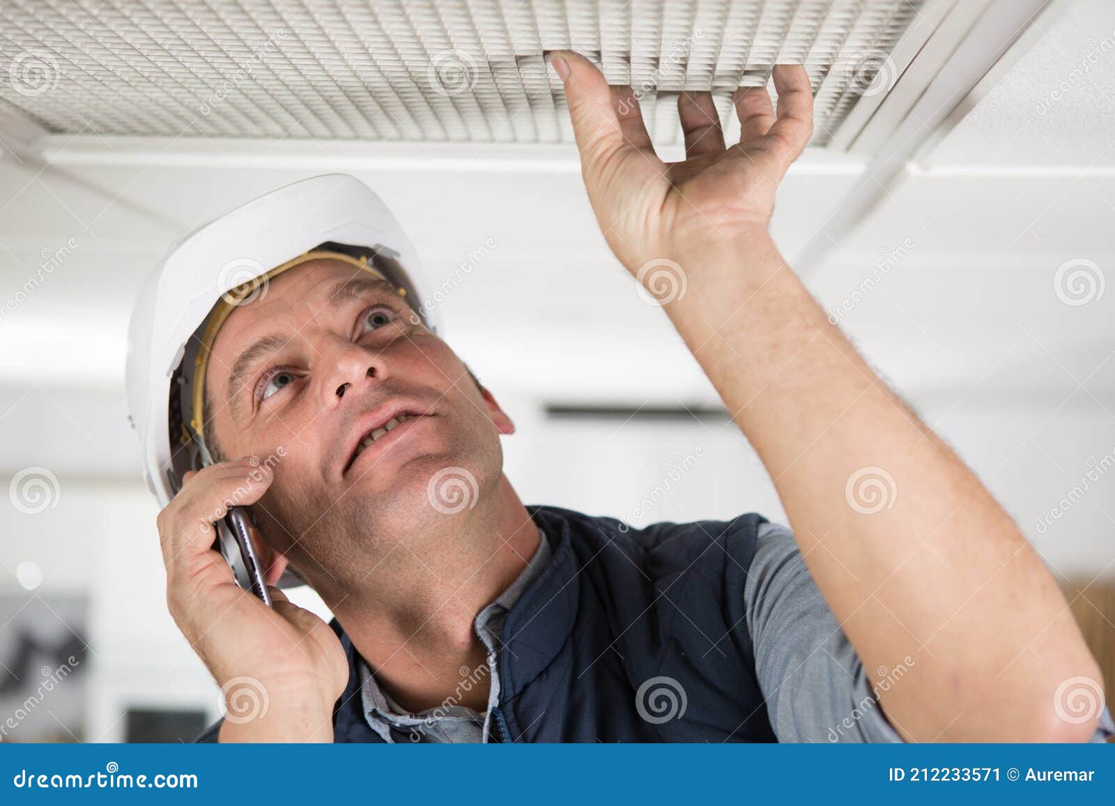 Builder on Cell Phone Checking Ceiling State Stock Image - Image of ...