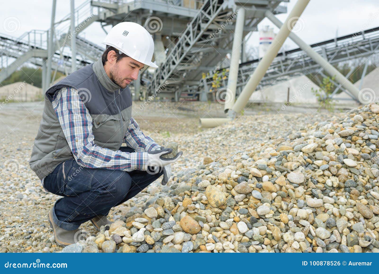 Builder Checking Pebbles Outside Construction Site Stock Photo - Image ...