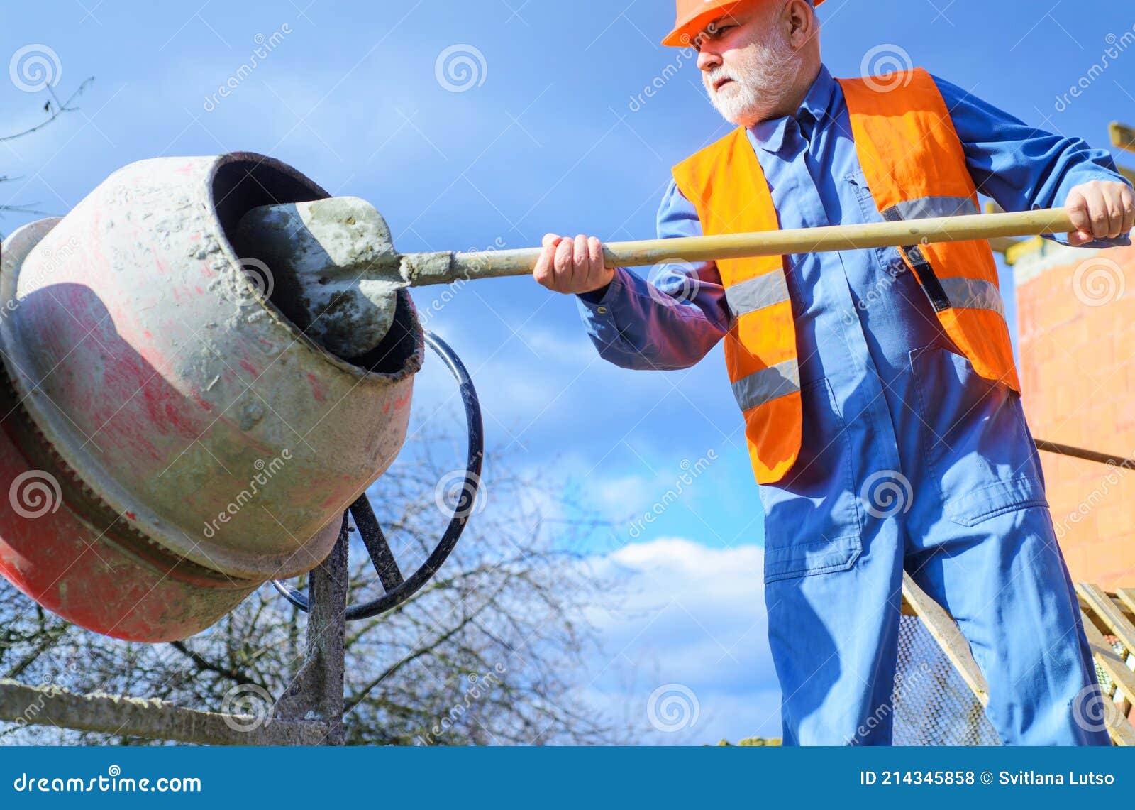 Builder with Concrete Mixer Prepares Cement Mortar. Construction Worker ...