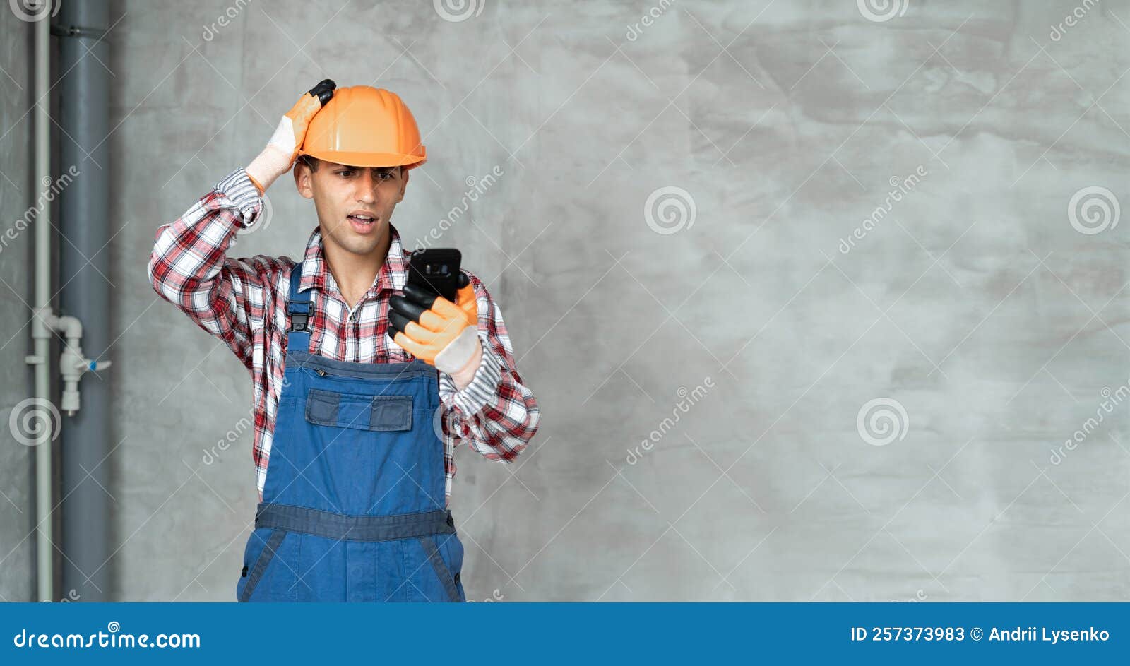 Builder Considered. Construction Worker is Holding Phone. Engineer ...
