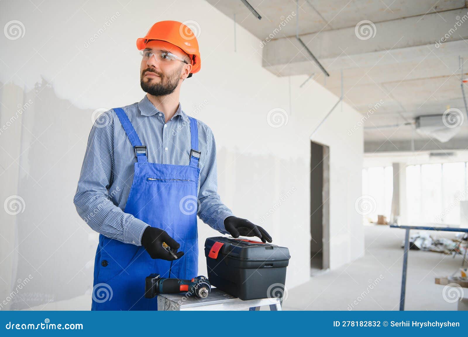 Builder on Construction Site with Tool Box Stock Photo - Image of ...
