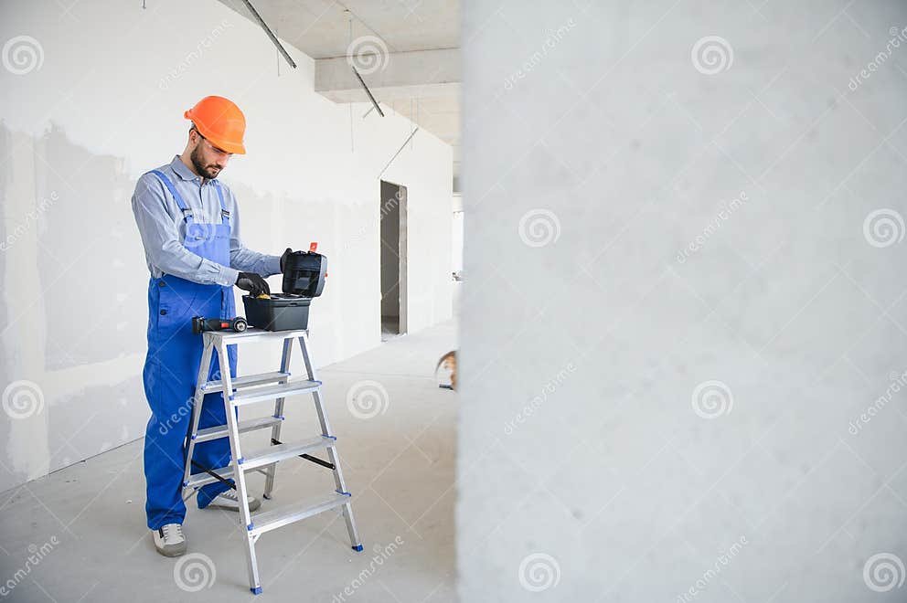 Builder on Construction Site with Tool Box Stock Photo - Image of ...