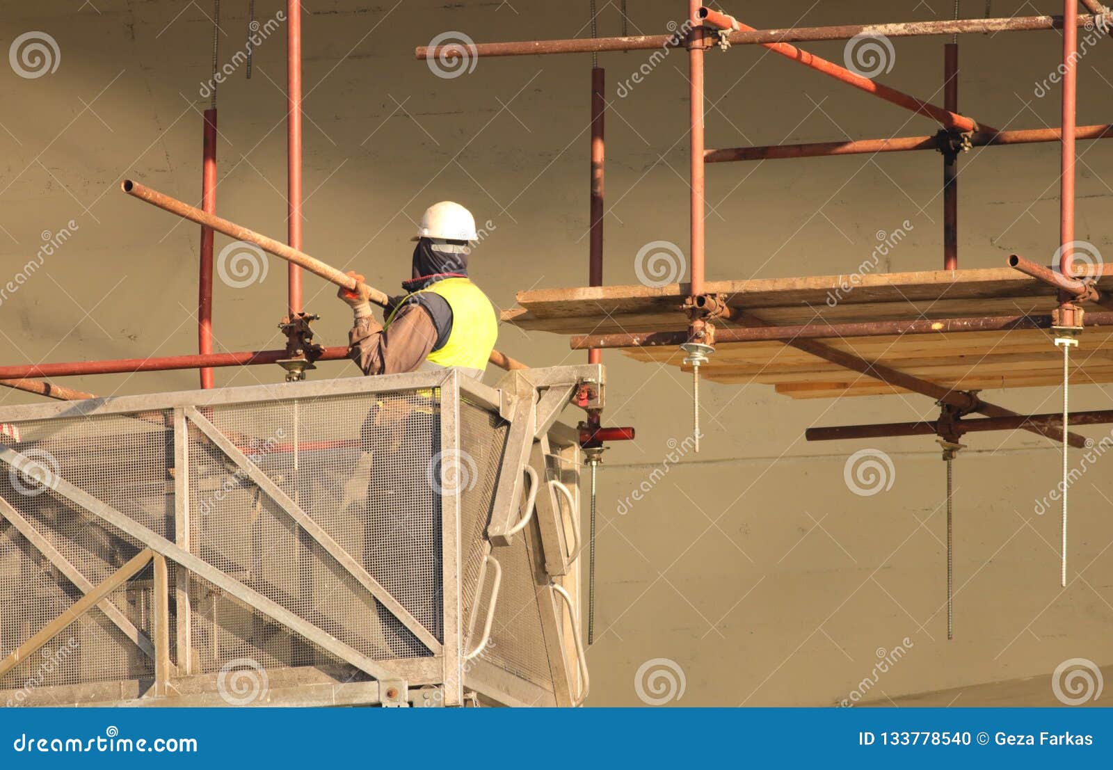 Builder at the Construction Site Work on Scaffolding Stock Photo ...