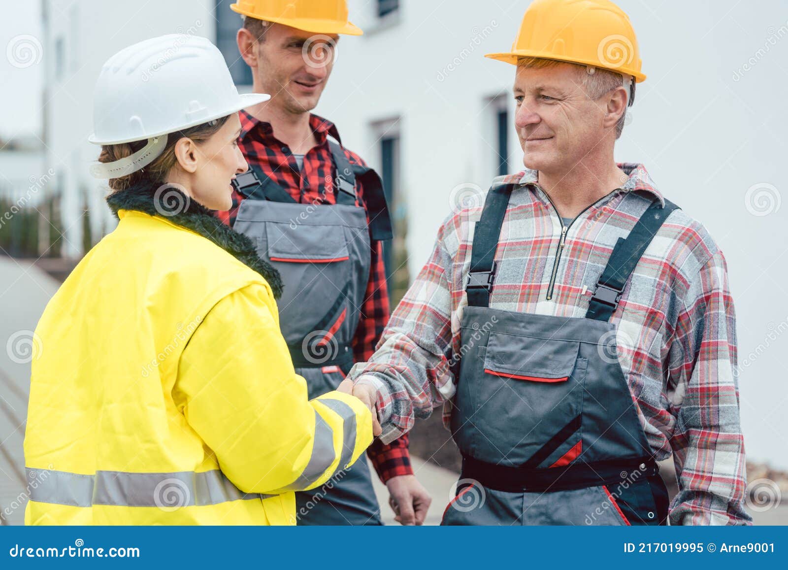 Builder and Contractor on Construction Site Shaking Hands in Acceptance ...