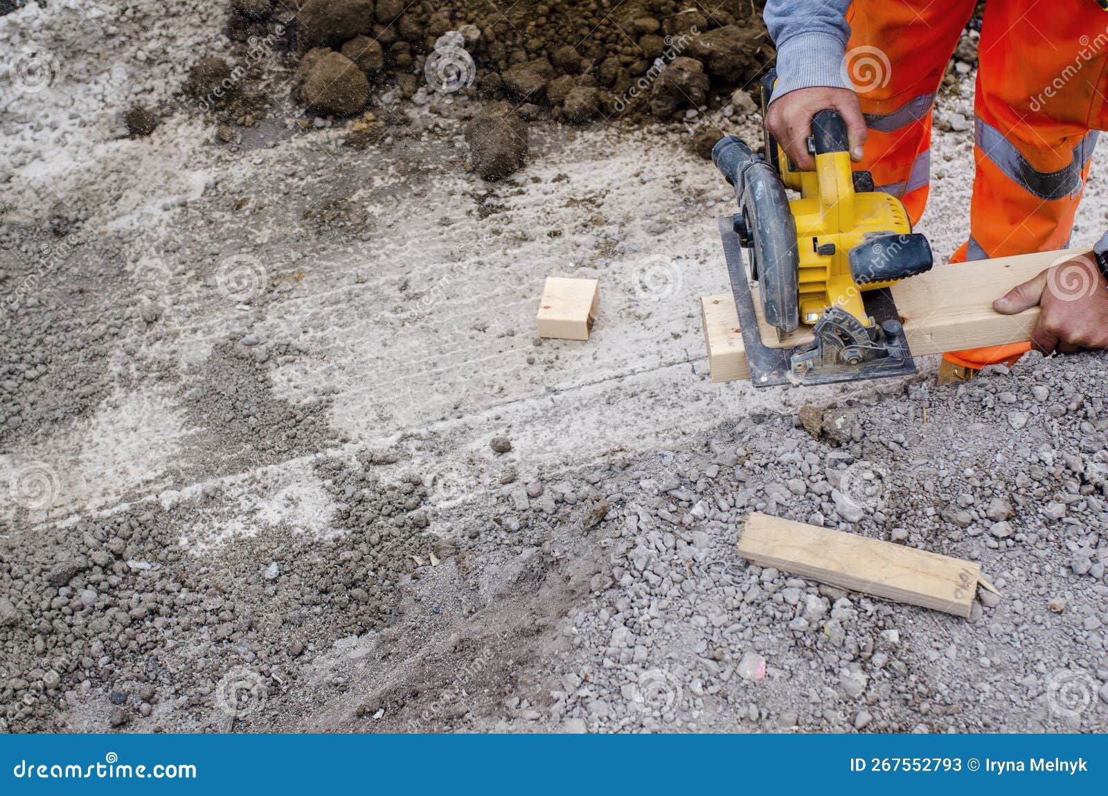 Builder Cutting Timber with a Cordless Battery-powered Circular Saw on ...