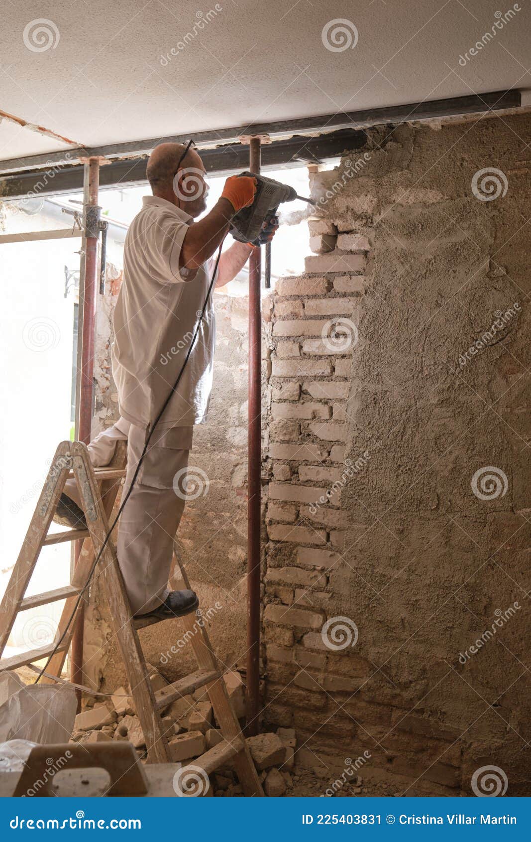 Builder with Demolition Hammer Breaking a House Wall. Stock Image ...