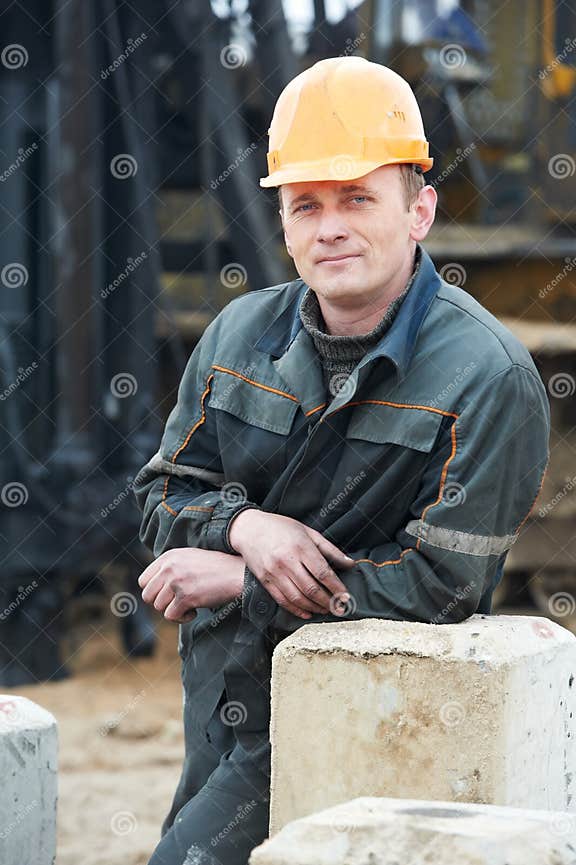 Builder in Dirty Workwear at Construction Site Stock Photo - Image of ...