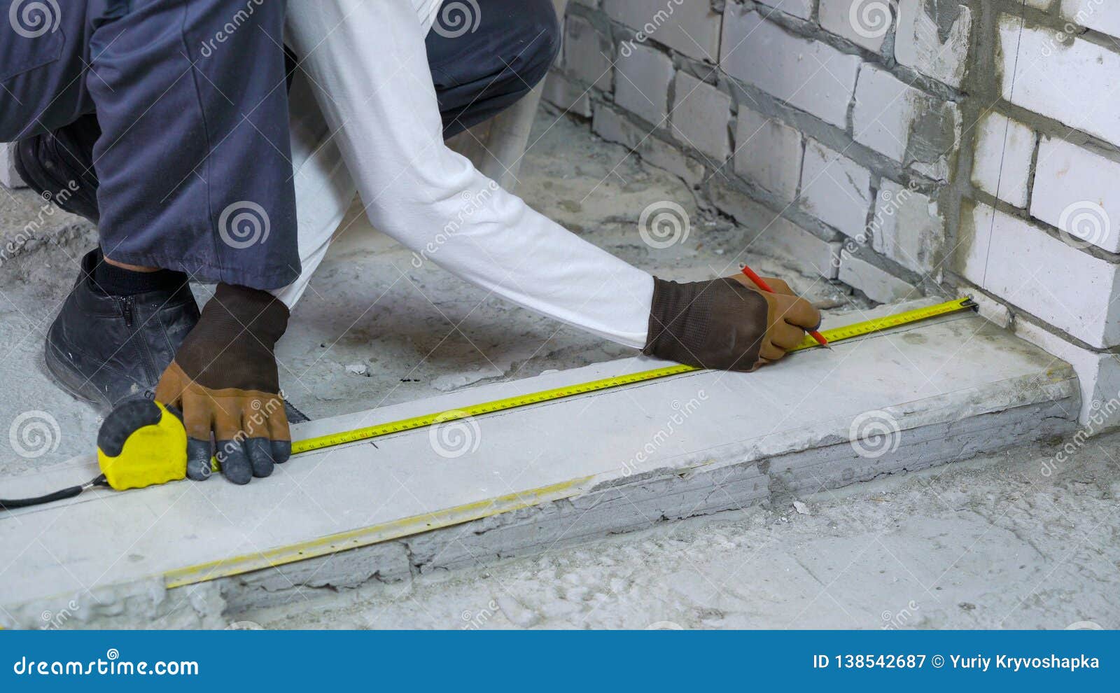 Builder Doing Measures with Measuring Tape and Pencil at Construction ...