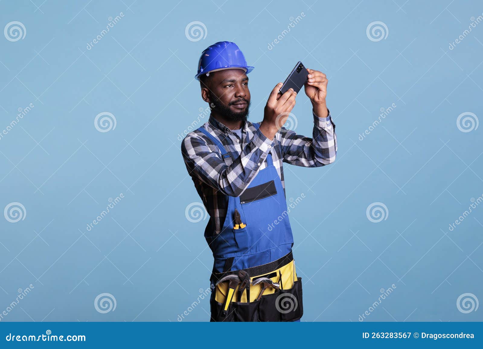 Builder Dressed in Work Uniform Using Mobile Device Stock Image - Image ...