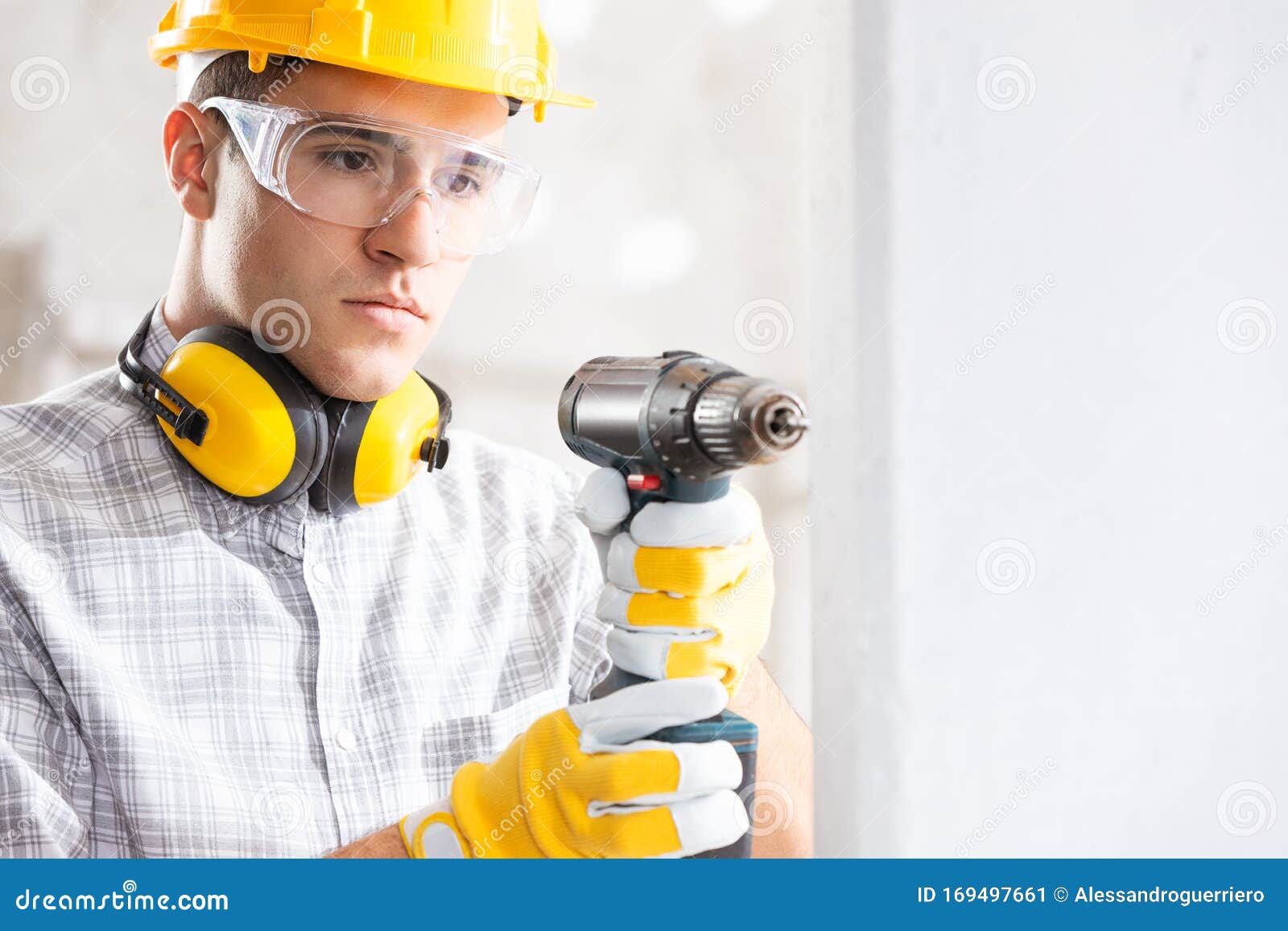 Builder Drilling Wall For Installing Anchors To Hold Rigid Insulation ...