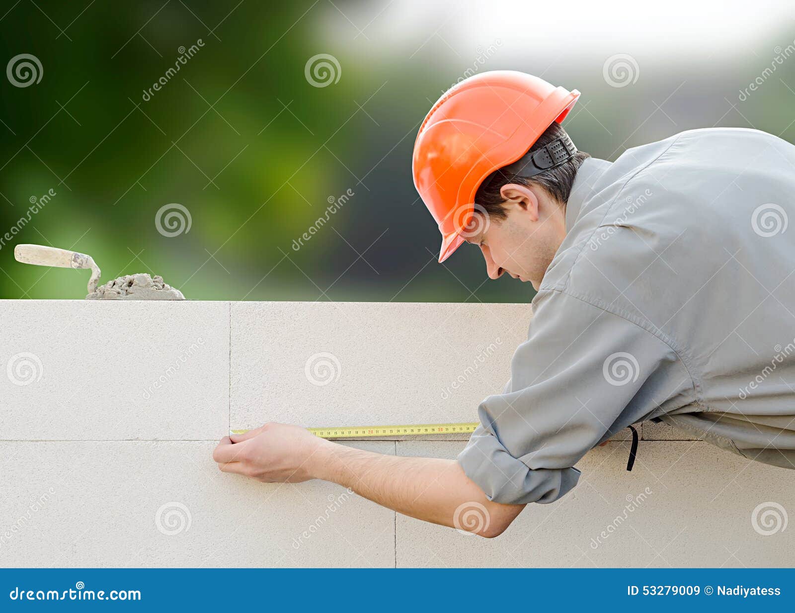Builder erects a wall stock image. Image of building - 53279009