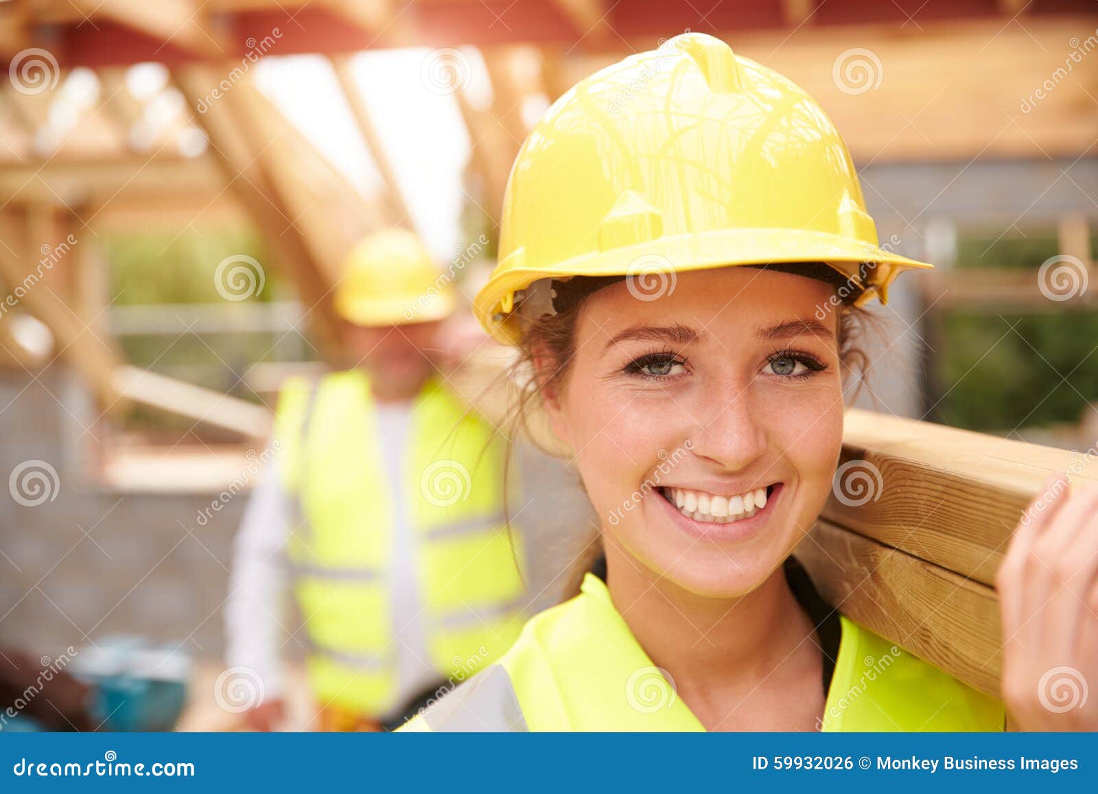 Builder and Female Apprentice Carrying Wood on Site Stock Photo - Image ...