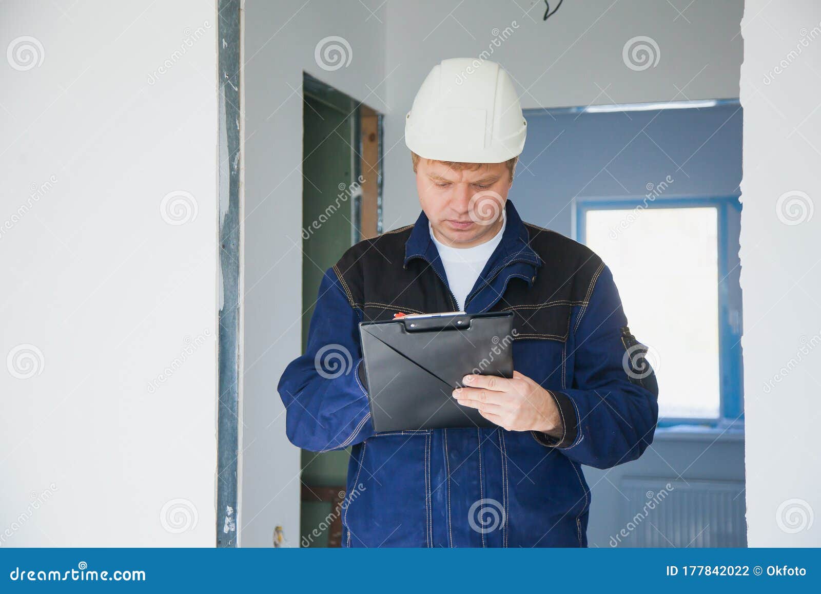 Builder Foreman in a White Helmet at a Construction Site Indoors Stock ...