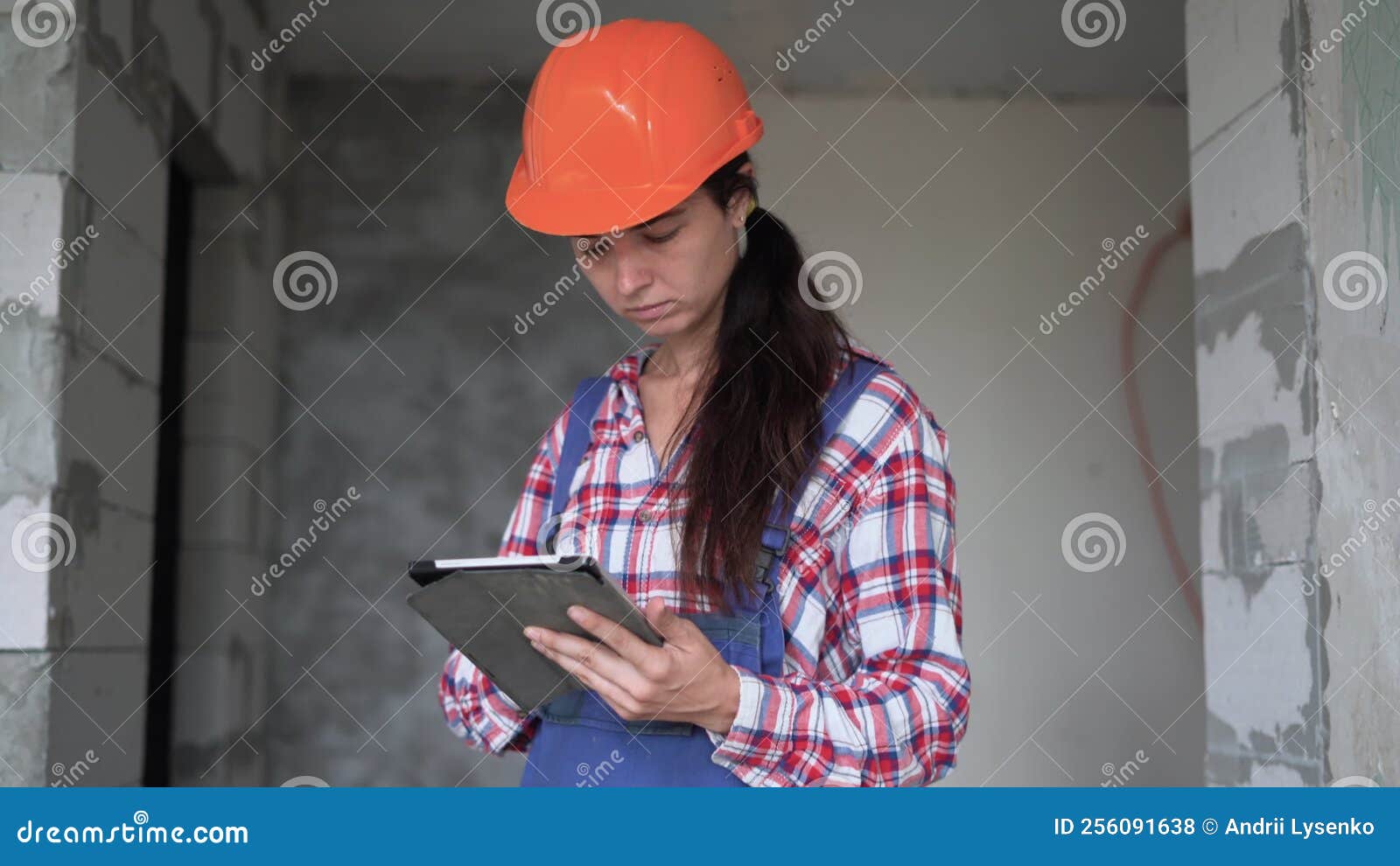 Builder with Gadget in Building Under Construction. Modern Construction ...