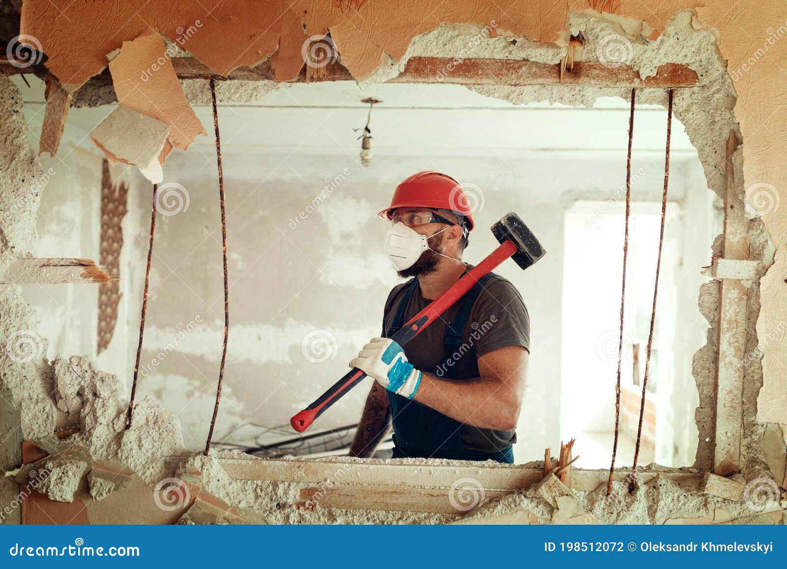 Builder with a Hammer in His Hands Breaks the Cement Wall the Builder ...