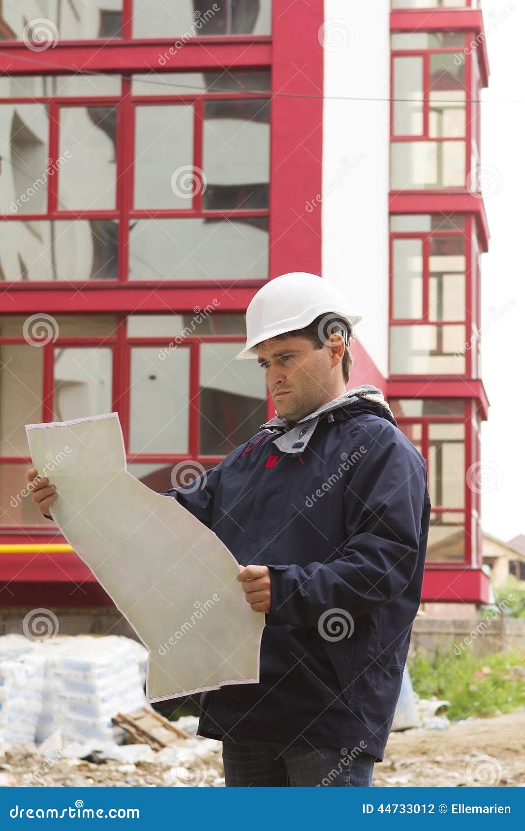 Builder in Helmet with Blueprint on Building Site Stock Photo - Image ...