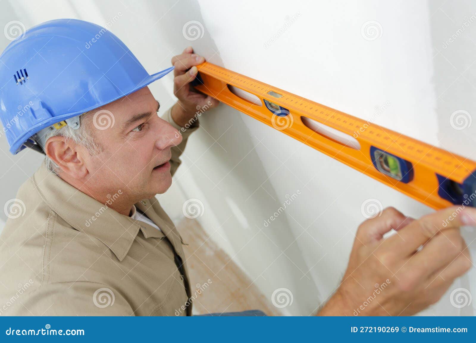 Builder in Helmet Measuring Wall with Level Stock Image - Image of ...