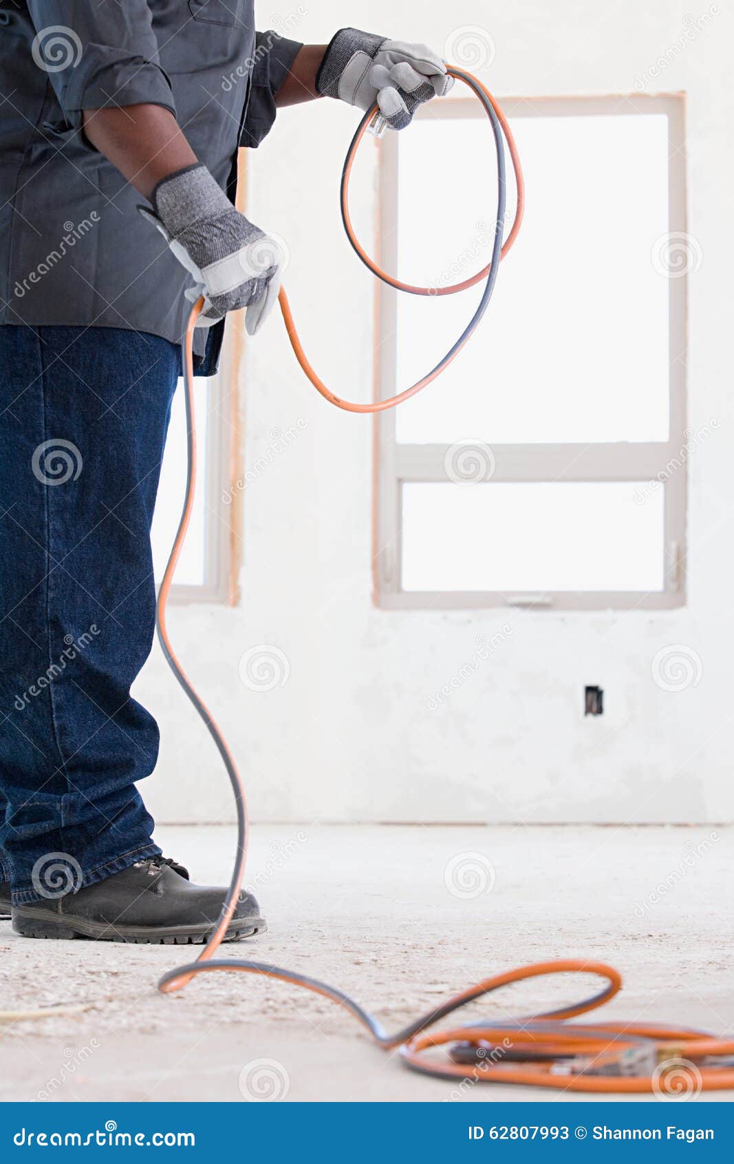 A builder holding a cable stock image. Image of hazard - 62807993